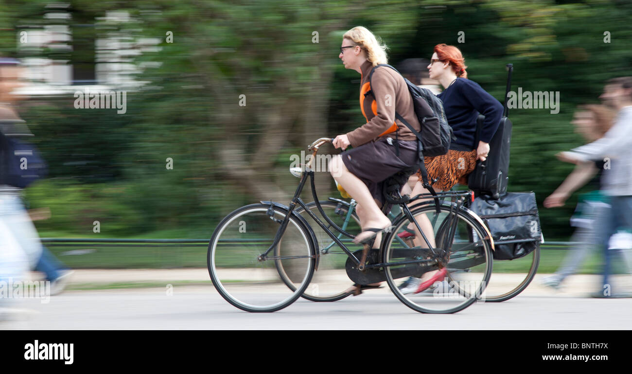People cycle through a city park Stock Photo - Alamy