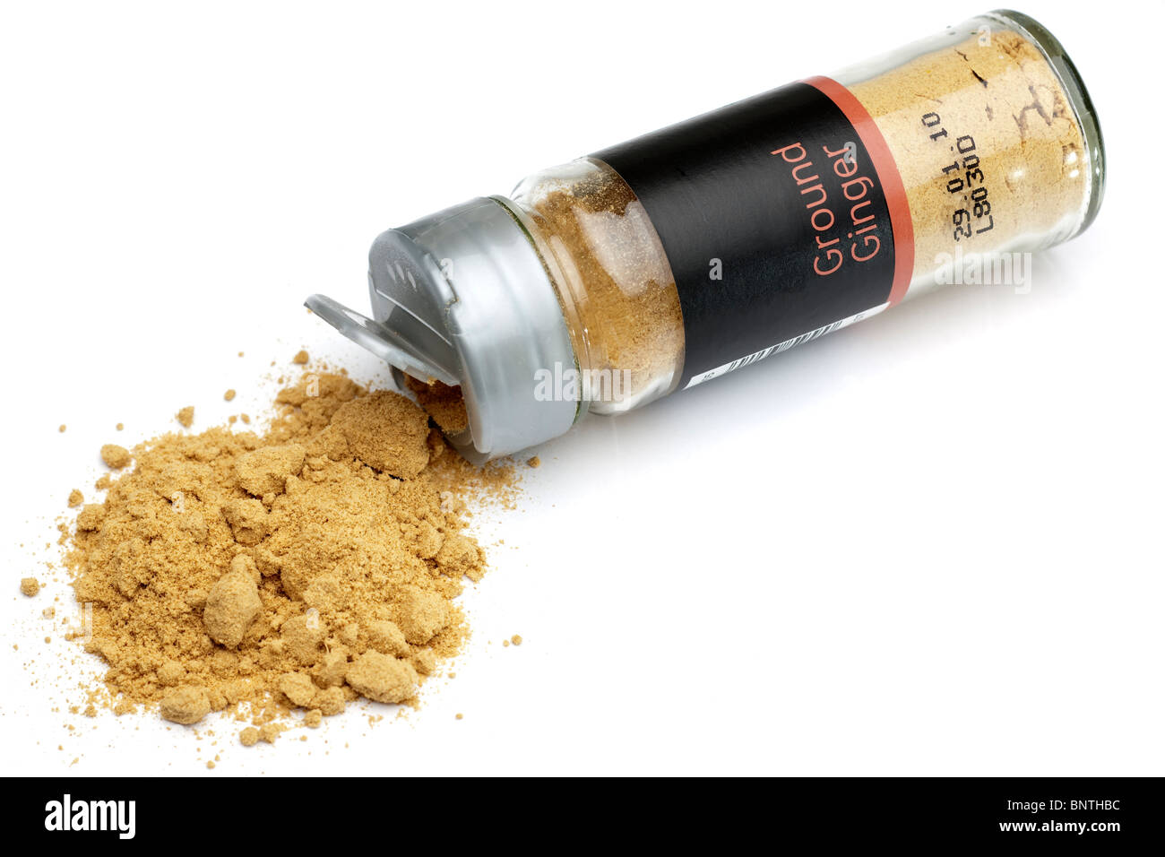 Pile of Ground ginger spilliing from a small glass container Stock ...