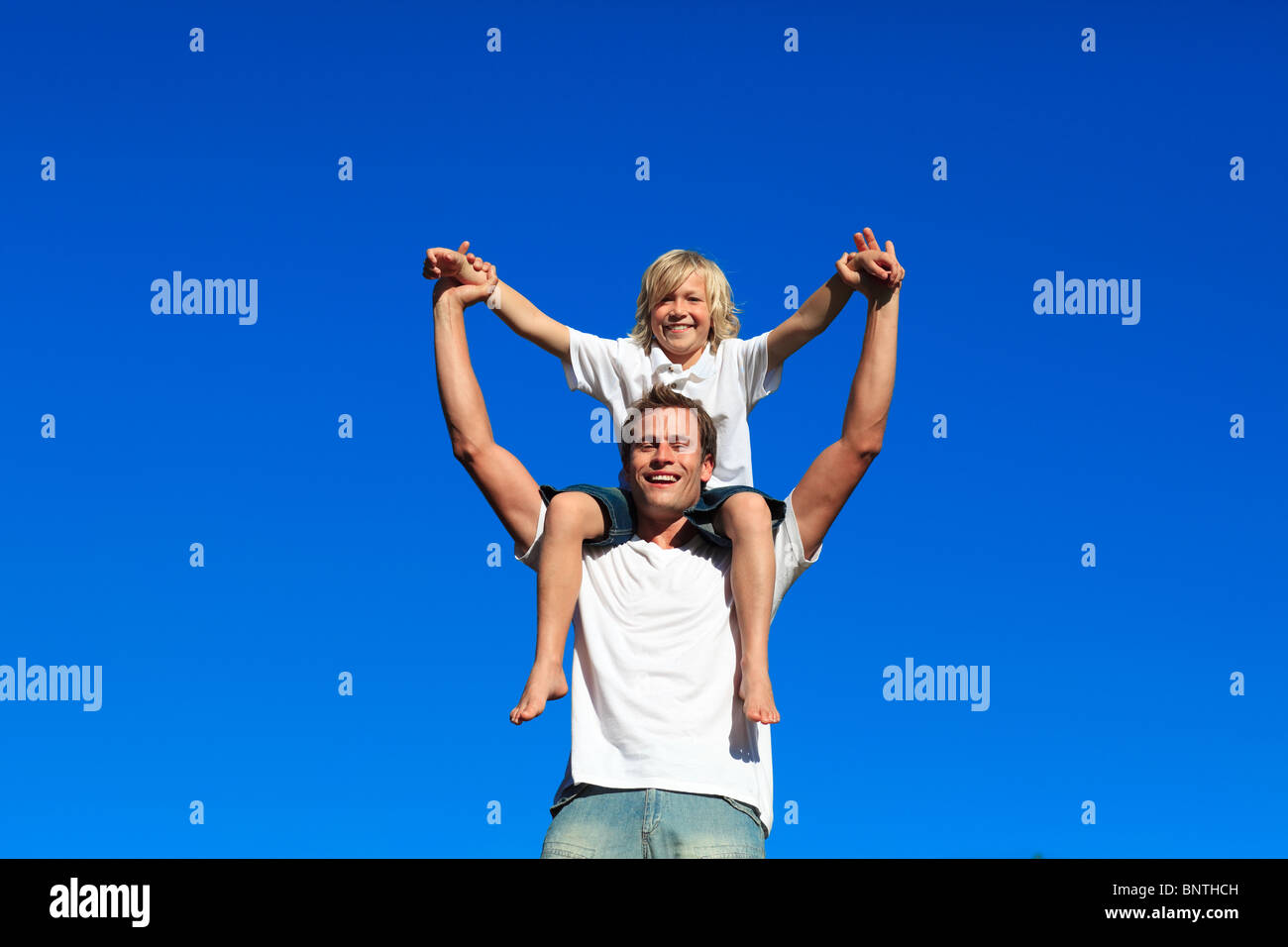 Father giving his son a piggyback ride Stock Photo - Alamy