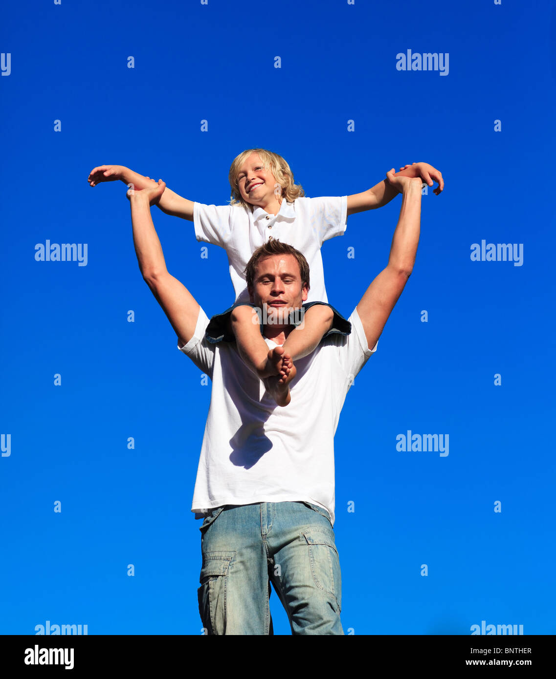 Dad giving his son a piggyback ride Stock Photo - Alamy