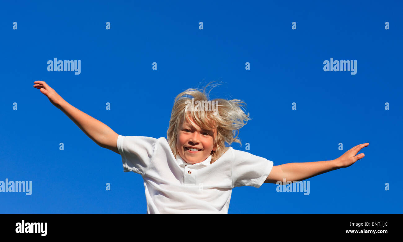 Smiling kid Jumping in the air Stock Photo - Alamy