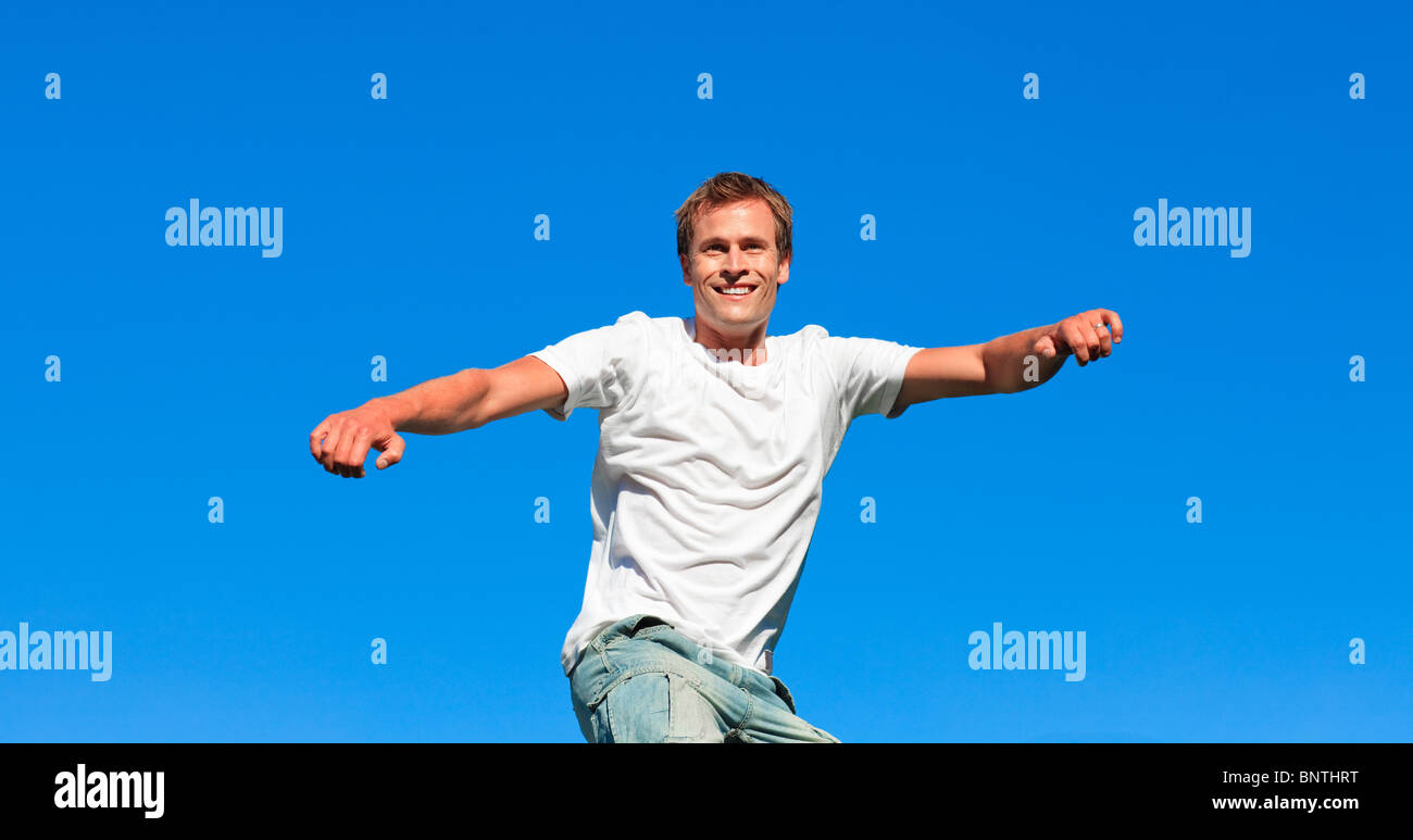 Lively man jumping in the air Stock Photo - Alamy