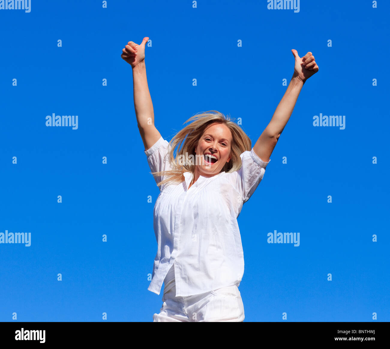 Lively woman jumping in hi-res stock photography and images - Alamy