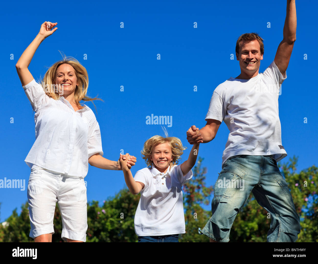 Lively family jumping in the air Stock Photo - Alamy