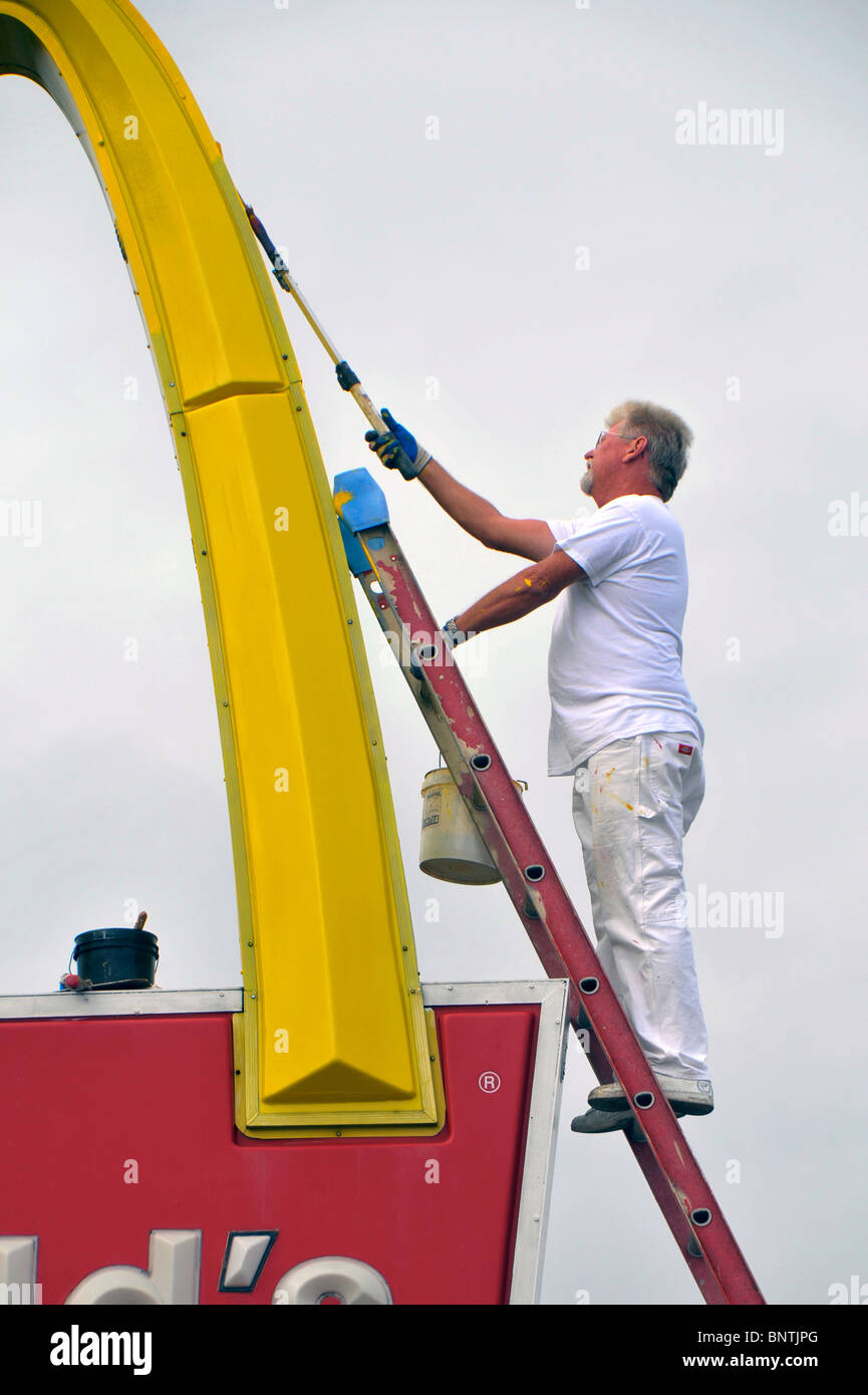 Restoration painting repair on commercial sign Stock Photo - Alamy