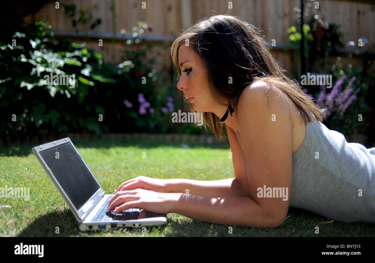 Young woman female using laptop computer in garden Stock Photo - Alamy