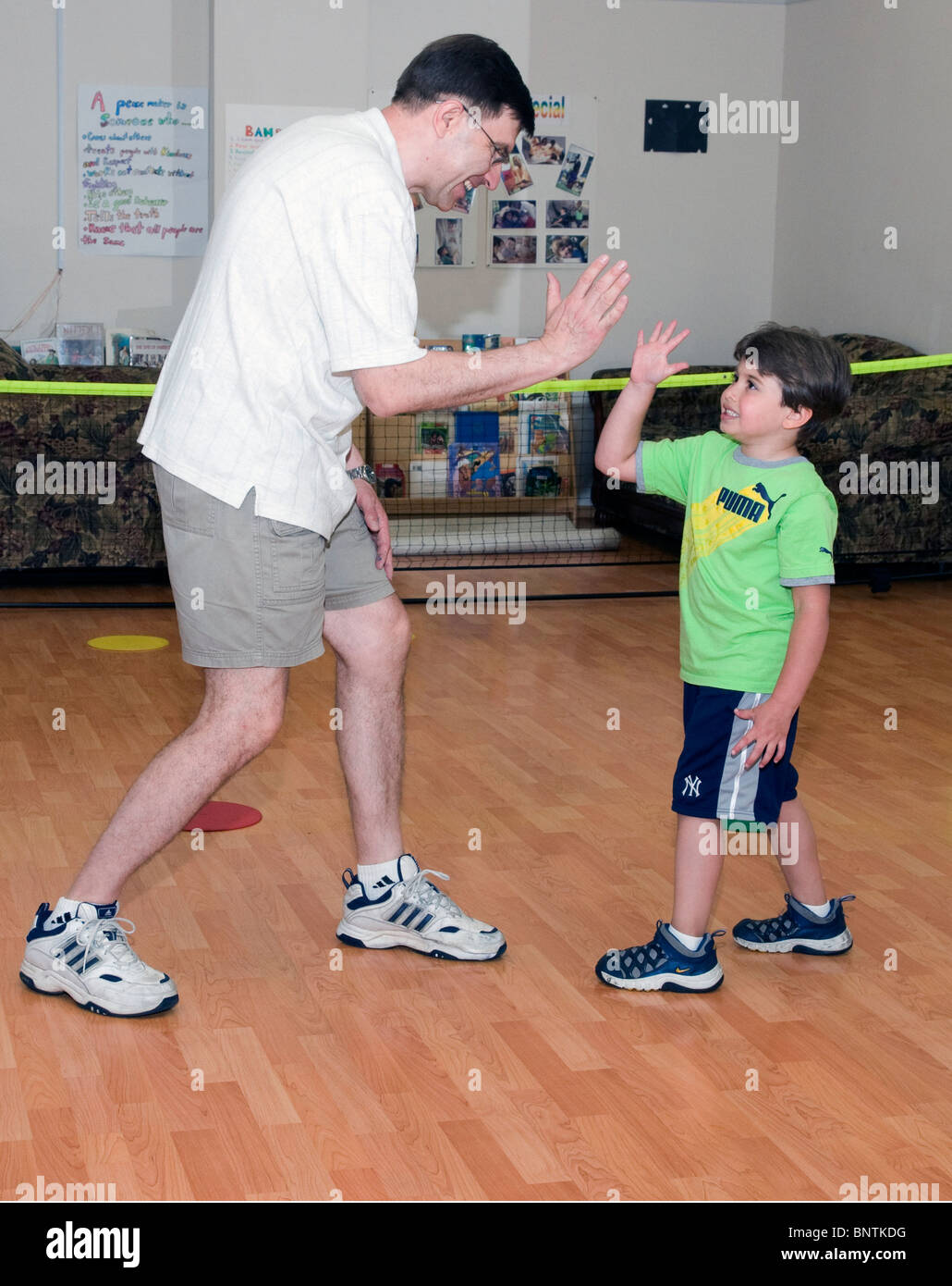 Little boy and coach have fun.Tennis lesson for kids. Kindergarten ...