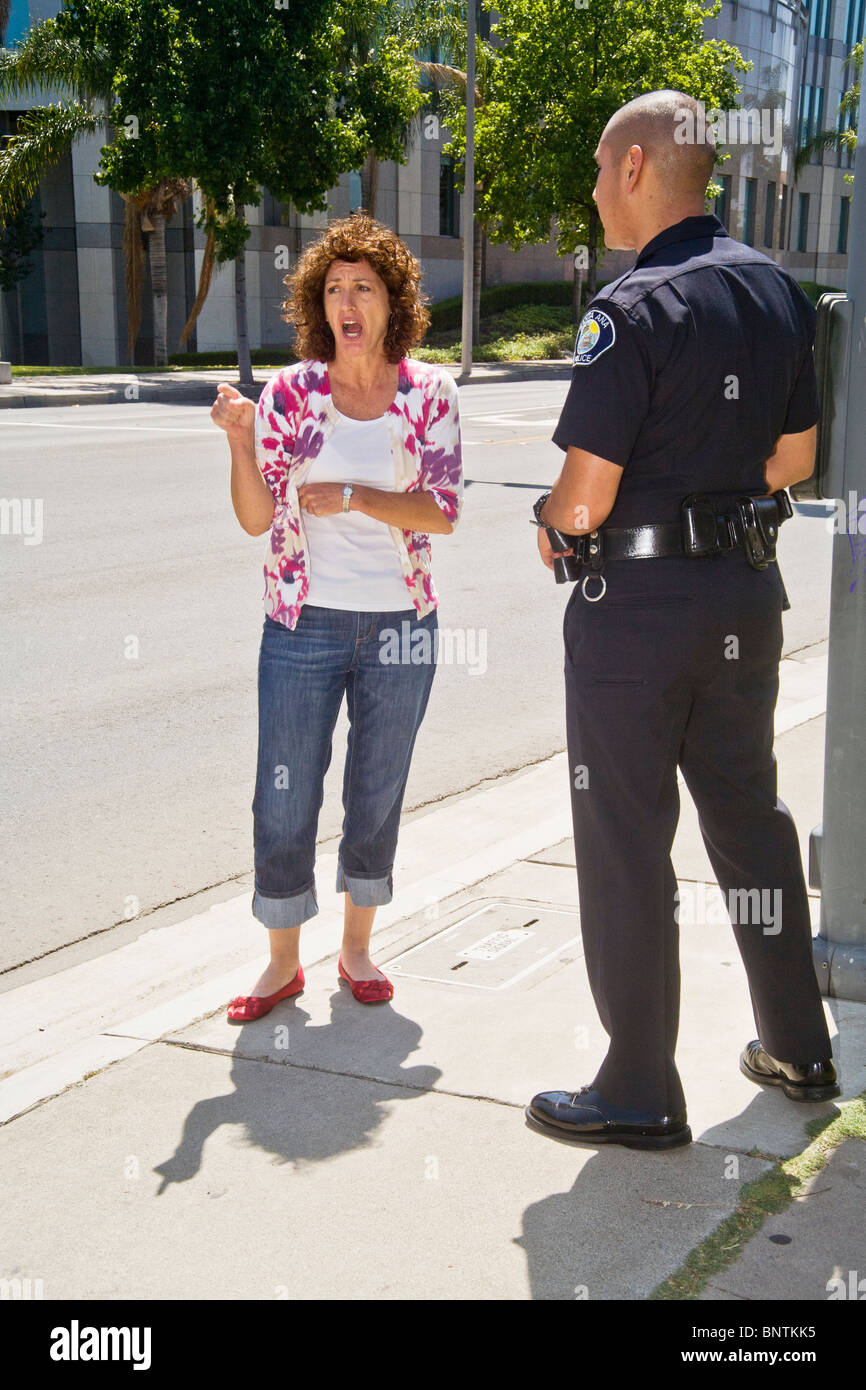 A woman argues with a Hispanic police officer after being stopped for a ...