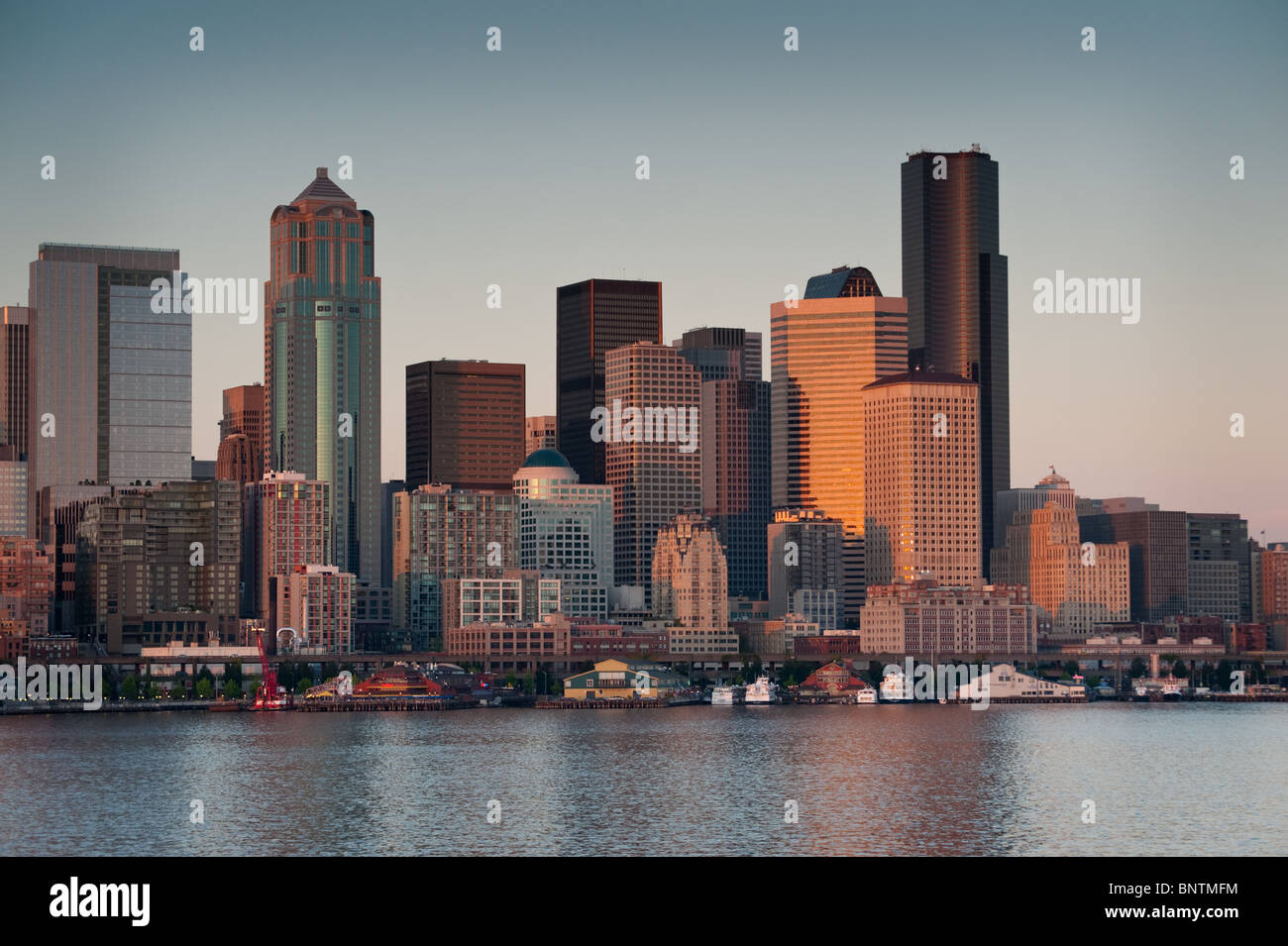 A beautiful summer sunset illuminates the Seattle skyline and the ...