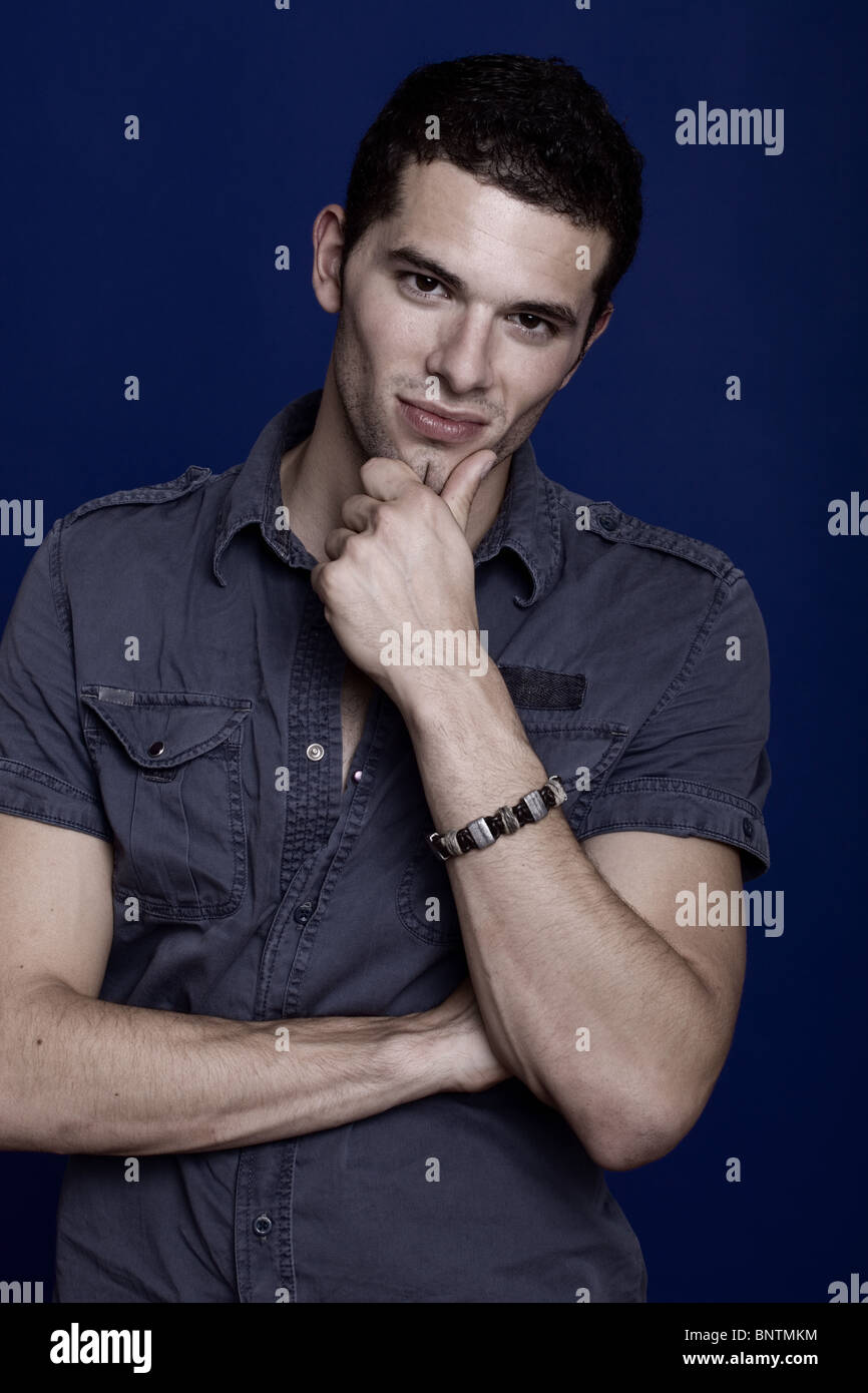 an casual young man portrait over a blue background Stock Photo - Alamy