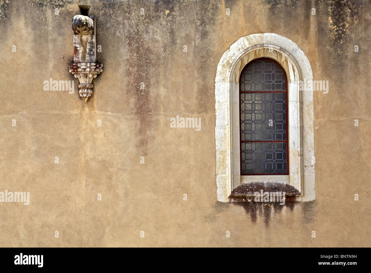 Medieval Church Window next to a Carved Stone Grotesque Gargoyle Stock ...