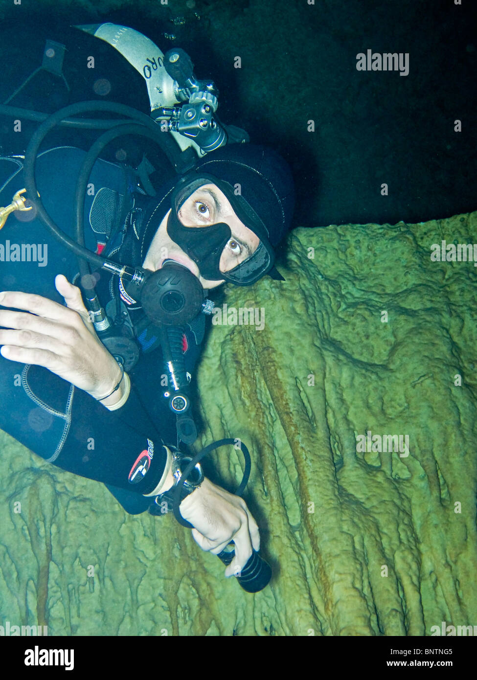 Man scuba diving into Chac Mool, one of the cave systems on the Yucatan ...