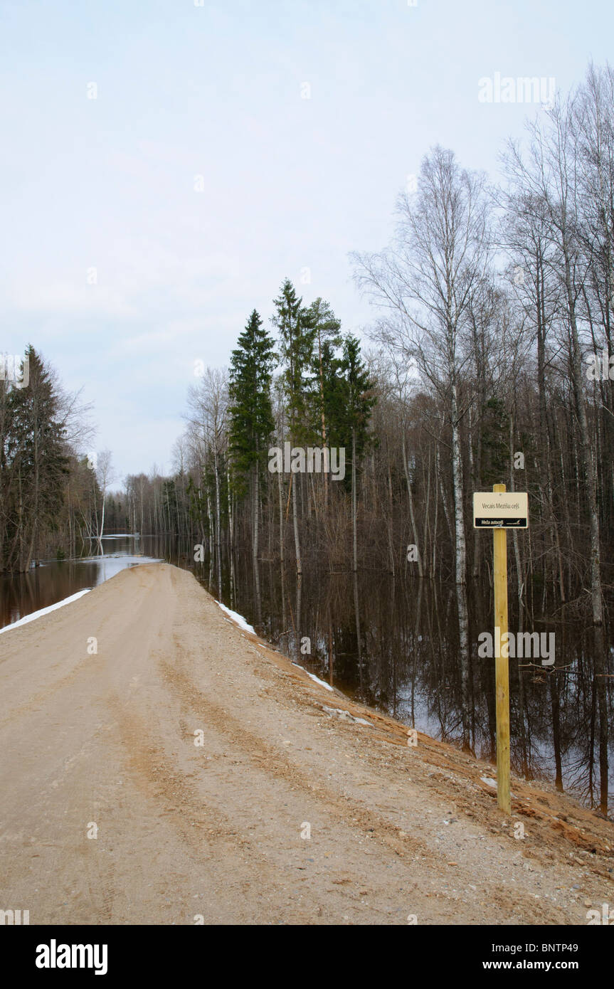 Unpaved road leading into water during spring floods Stock Photo - Alamy
