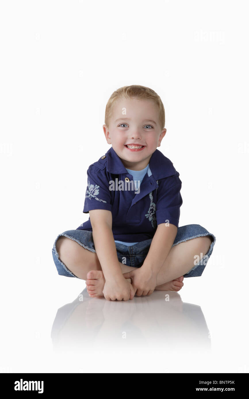 Boy Sitting with Legs Crossed Stock Photo - Alamy