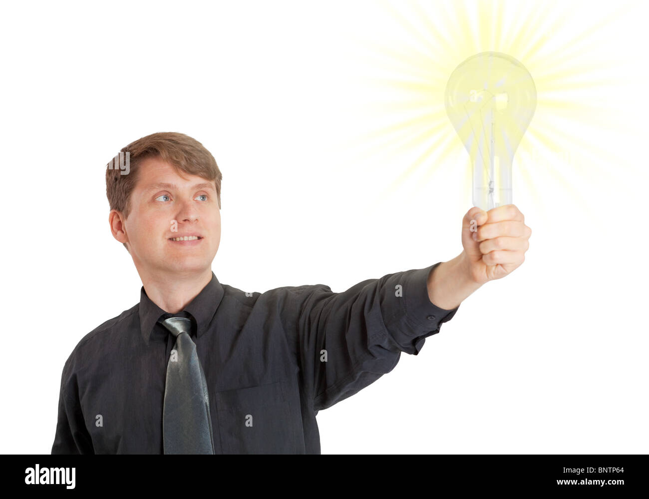 The young man lit by a bright idea in the form of electric light Stock ...