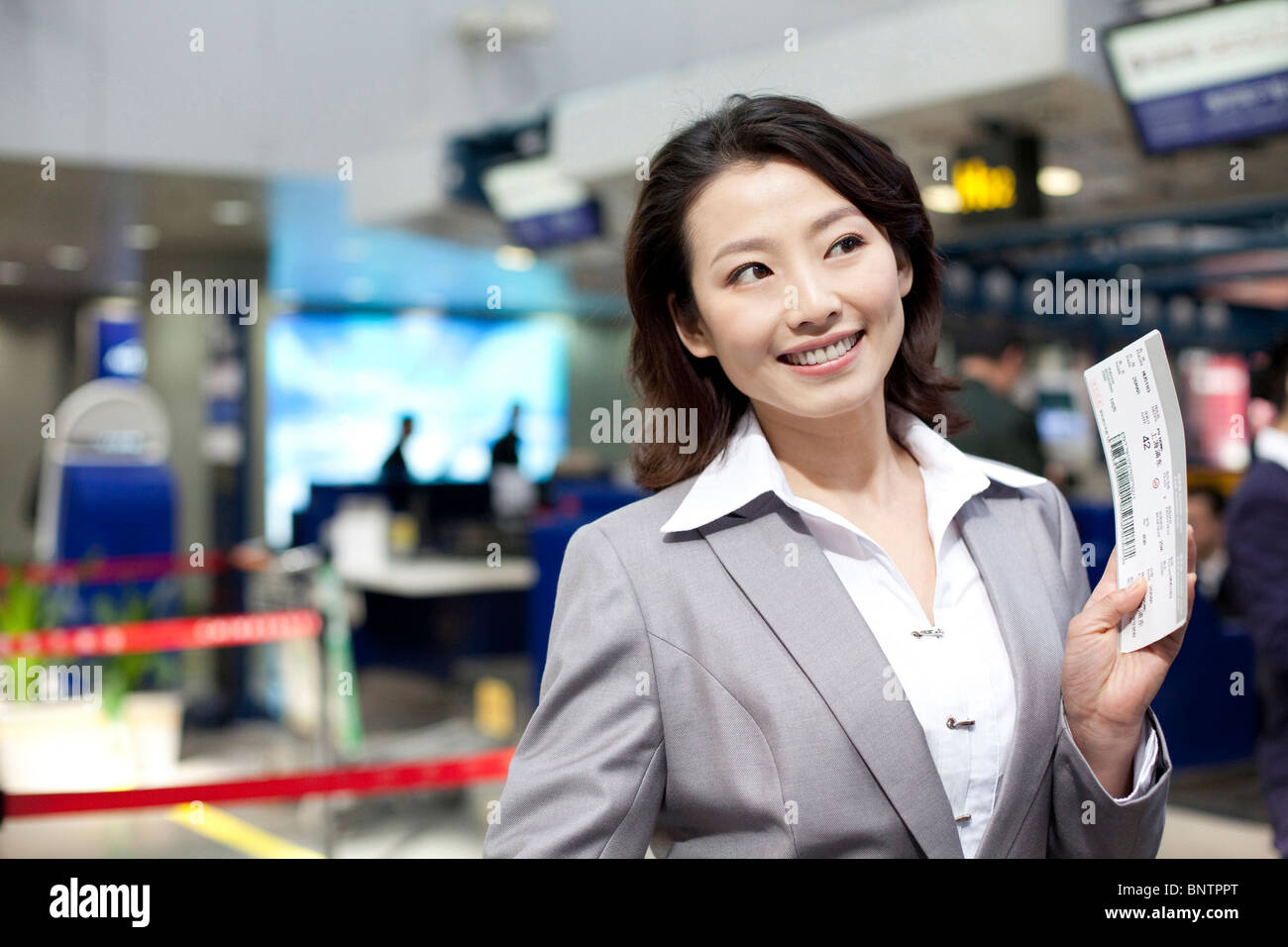 Businesswoman at the airport checkin Stock Photo - Alamy