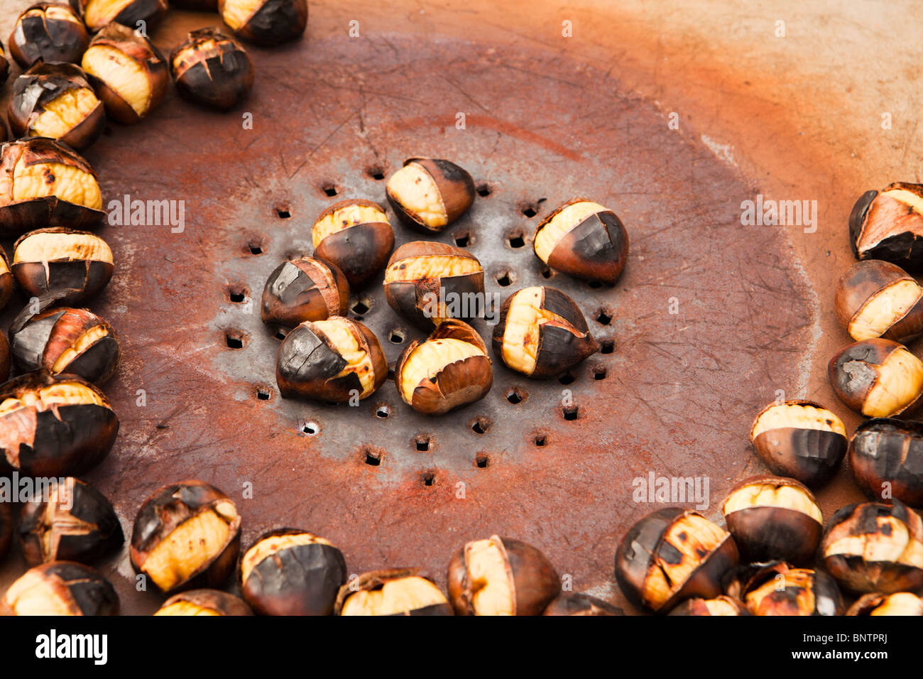 Roasted Chestnuts On An Iron Roasting Pan Stock Photo - Alamy