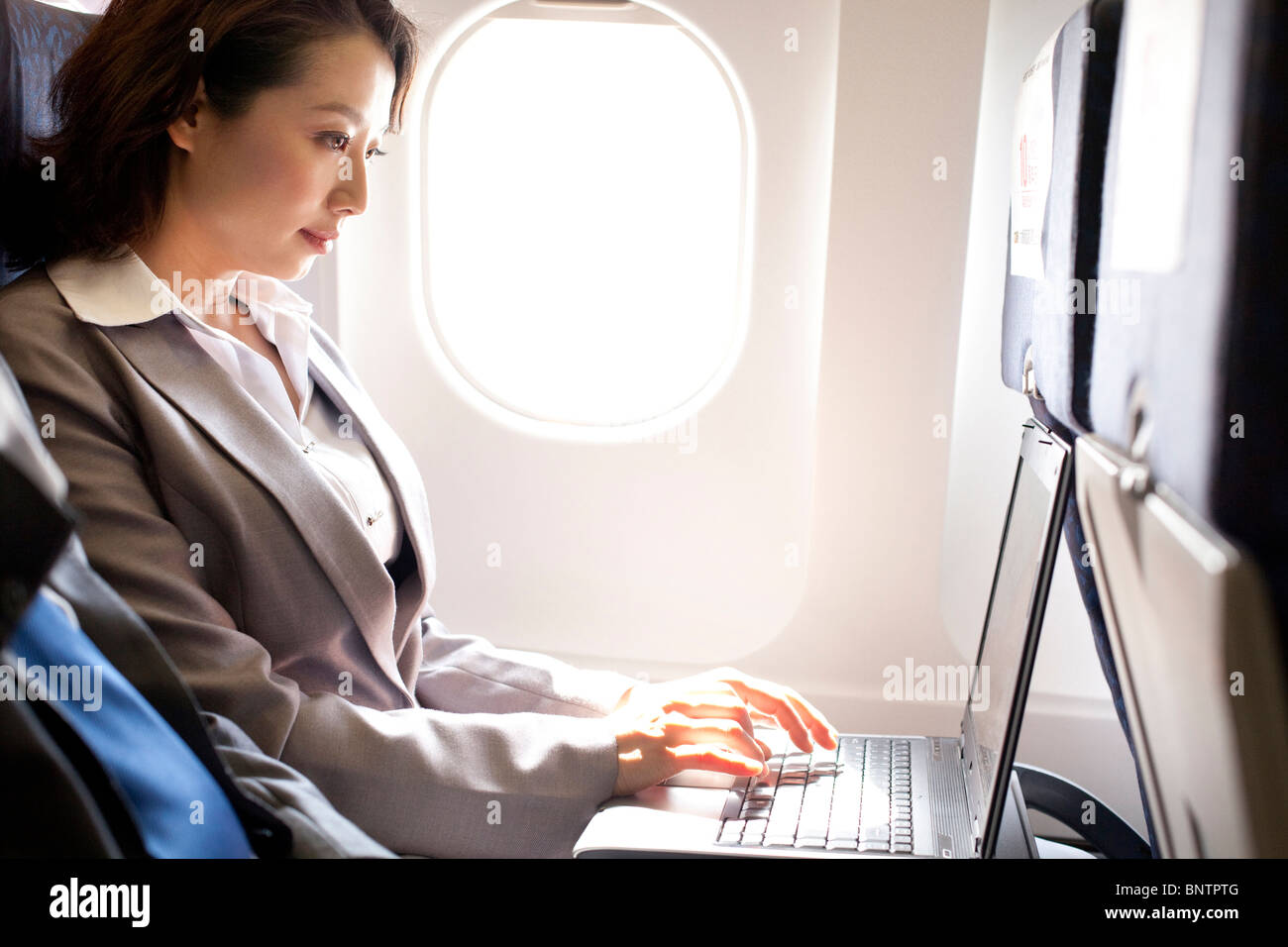 Businesswoman working on the plane Stock Photo - Alamy