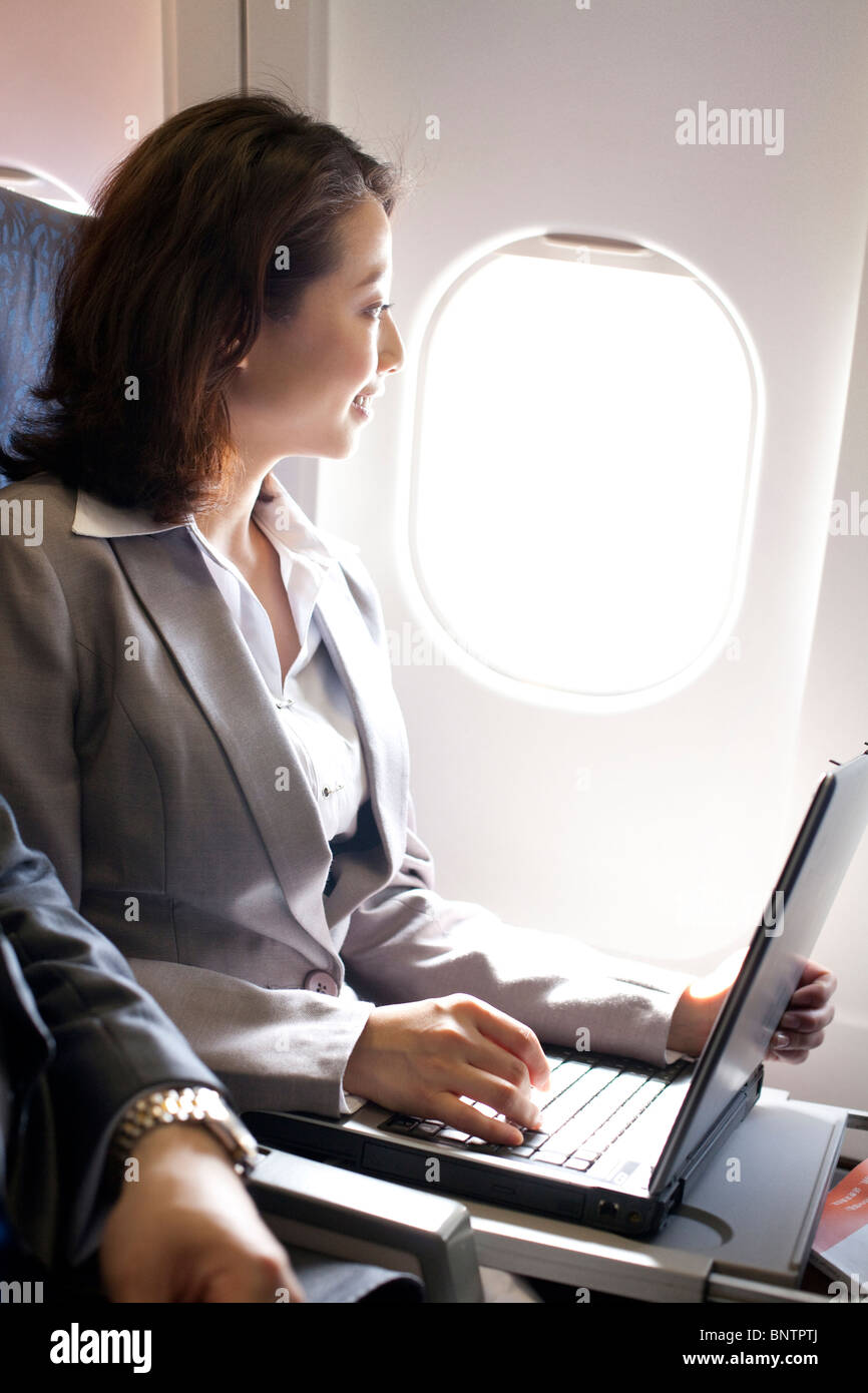 Businesswoman working on the plane Stock Photo - Alamy
