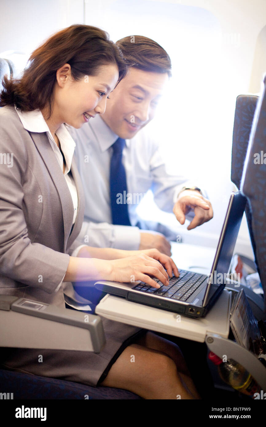 Businesspeople working on the plane Stock Photo - Alamy