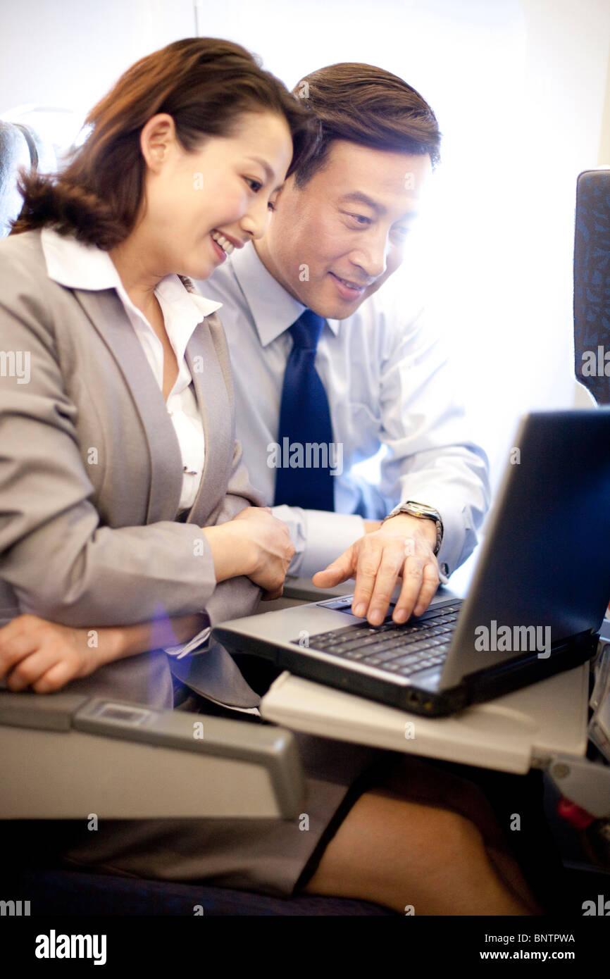 Businesspeople working on the plane Stock Photo - Alamy