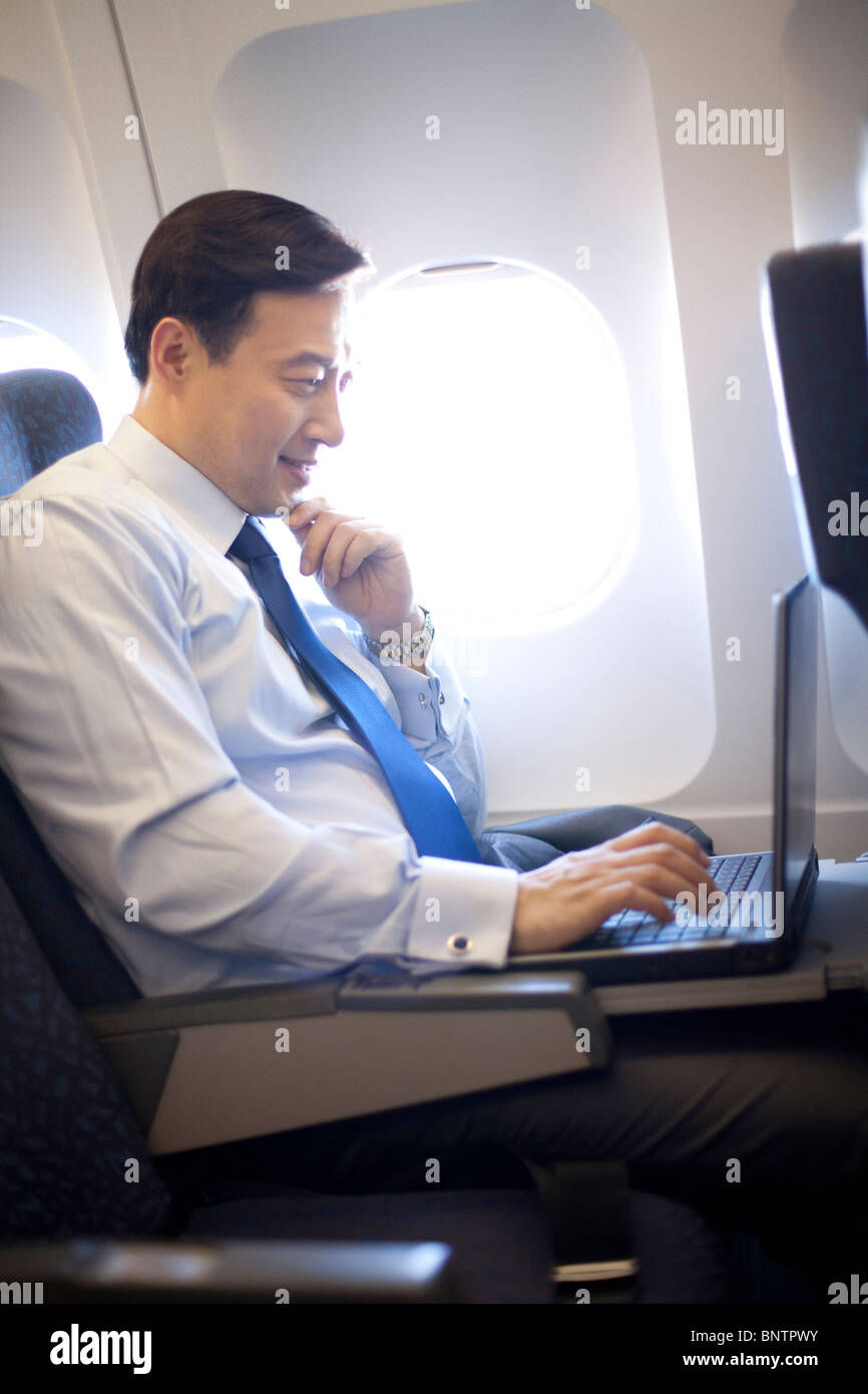 Businessman Plane Laptop Stock Photos & Businessman Plane Laptop Stock ...