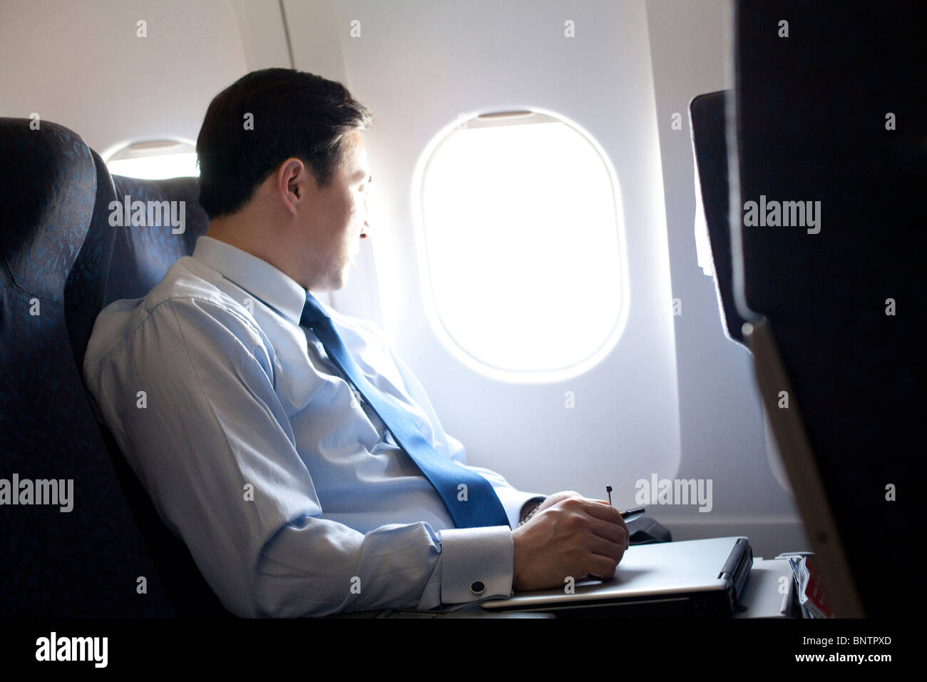 Businessman working on the plane Stock Photo - Alamy