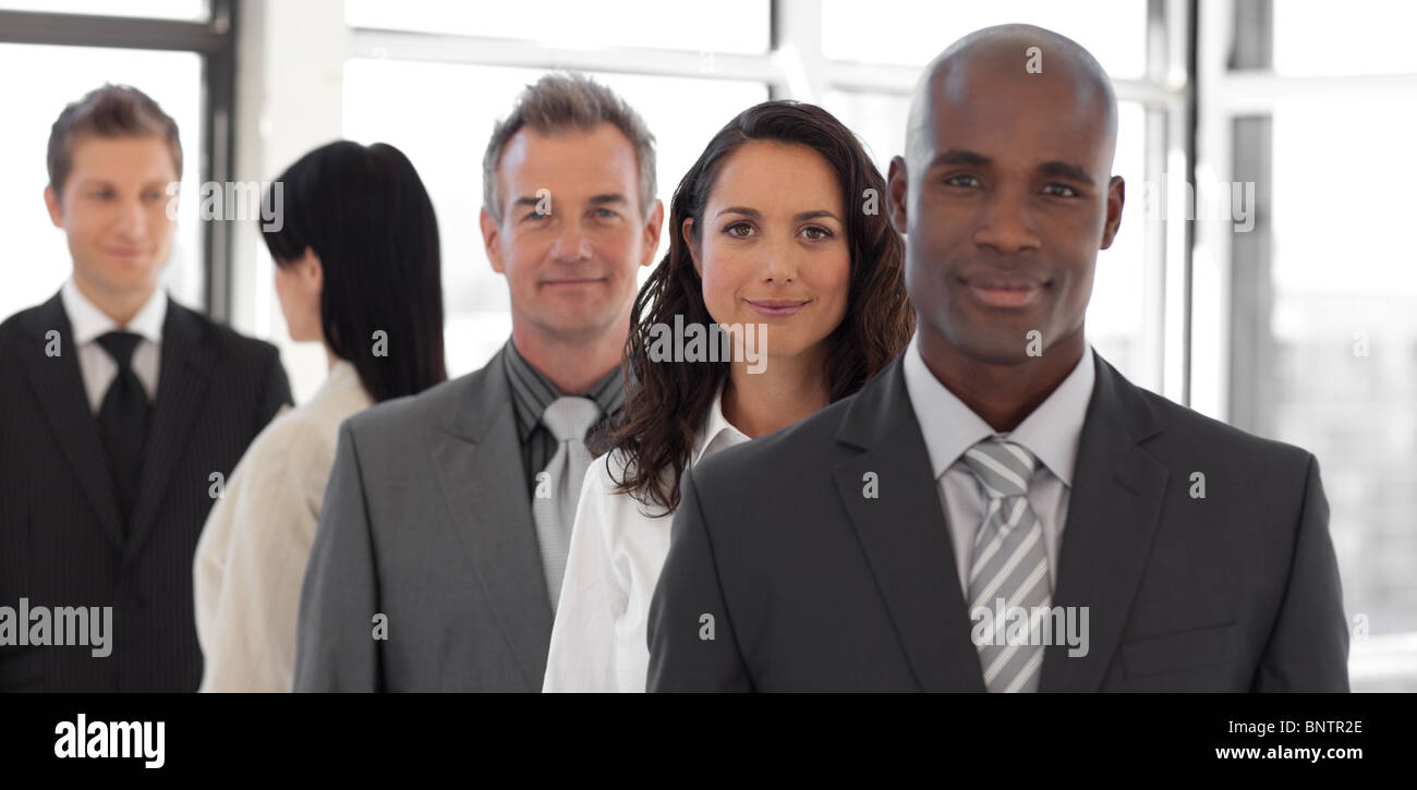 Serious business leader in front of business team Stock Photo - Alamy