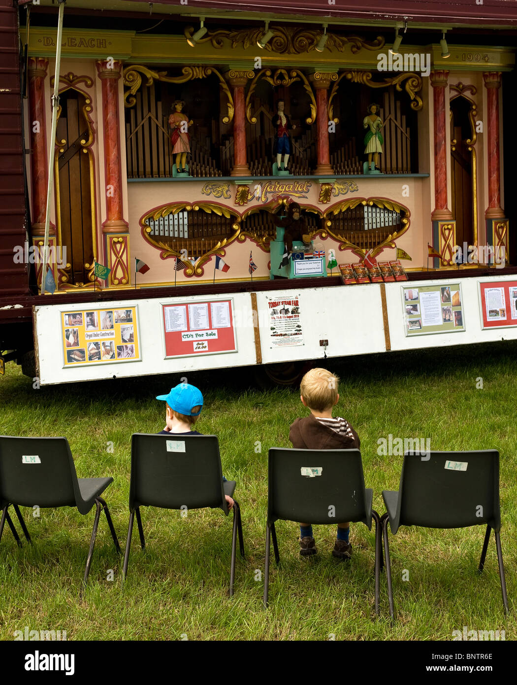 Two young boys watching a steam organ being played at the St Buryan ...