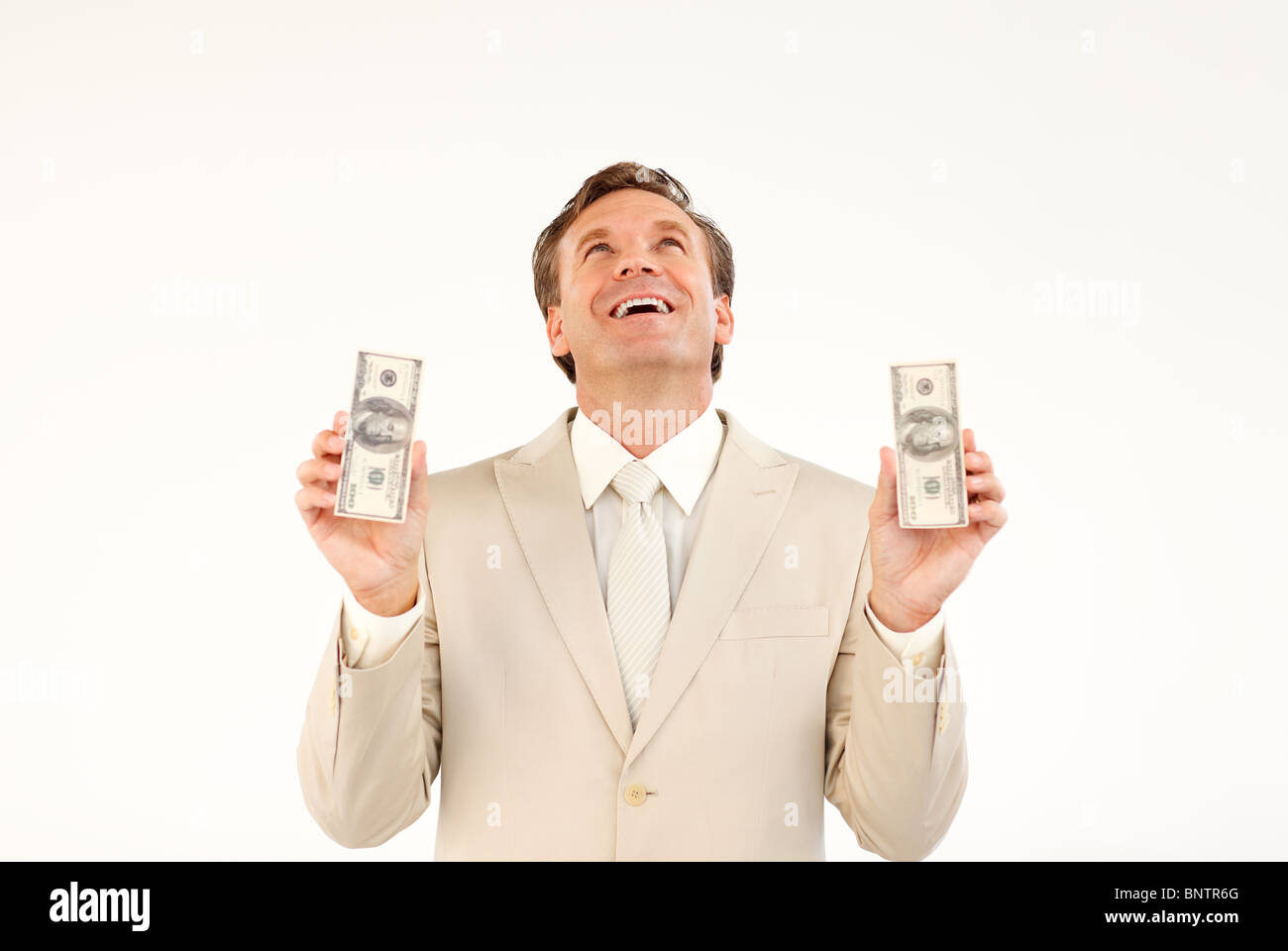 Businessman with money looking upwards Stock Photo - Alamy