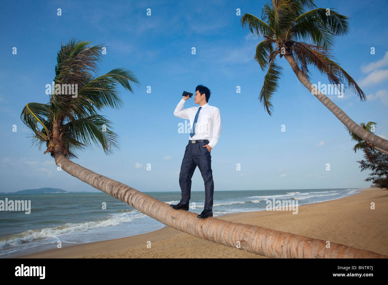 Businessman standing looking through telescope hi-res stock photography ...