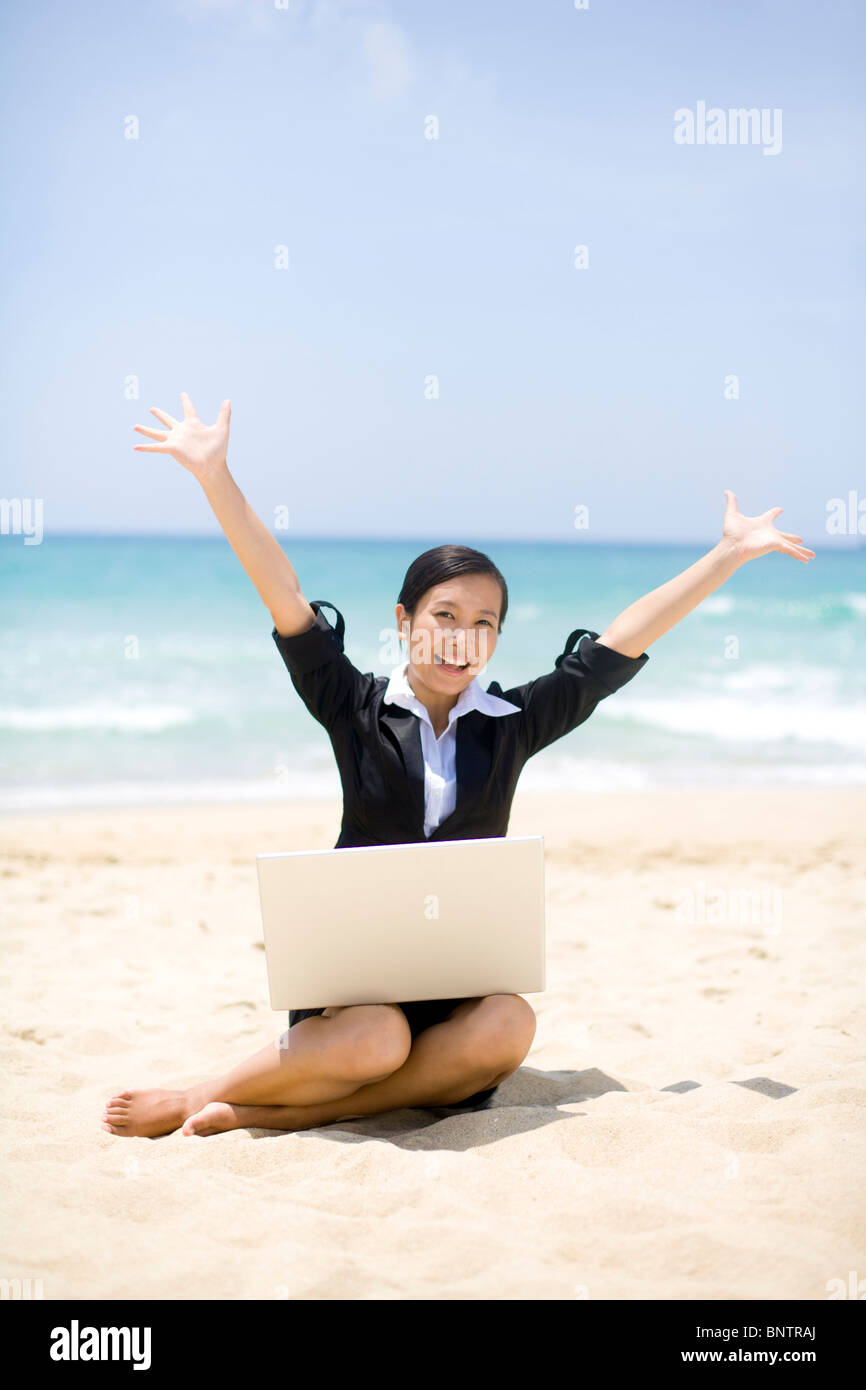 Businesswoman working on the beach Stock Photo - Alamy