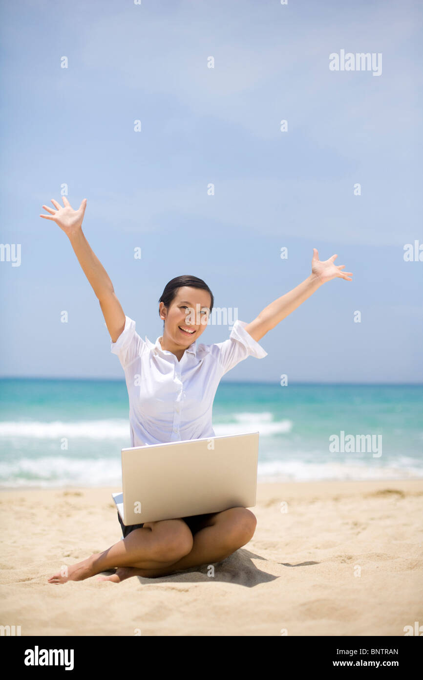 Businesswoman working on the beach Stock Photo - Alamy