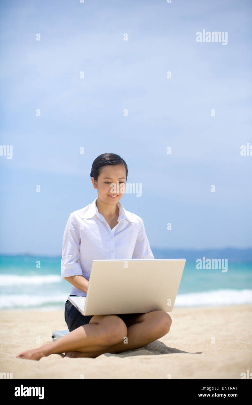 Businesswoman working on the beach Stock Photo - Alamy