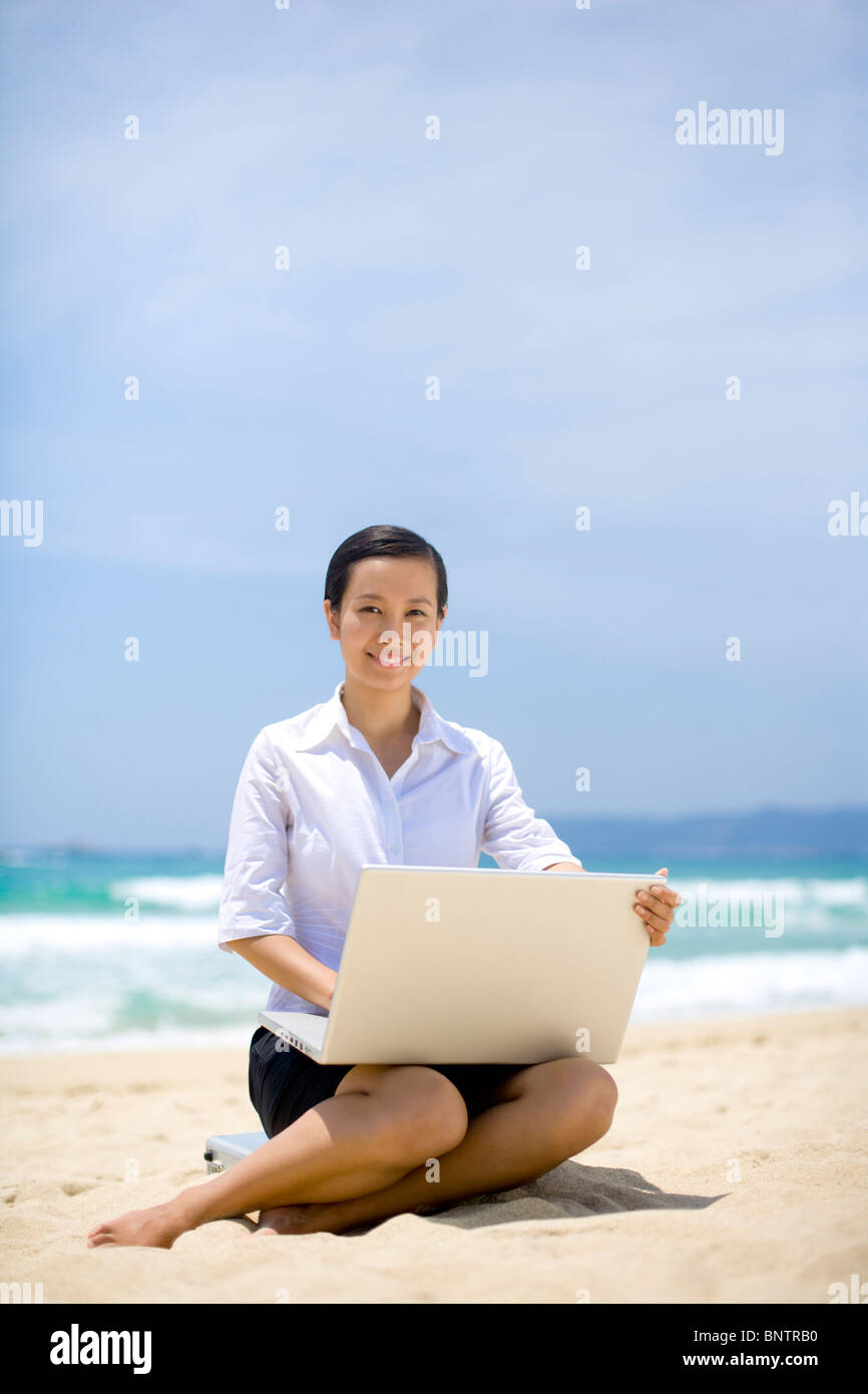 Businesswoman working on the beach Stock Photo - Alamy