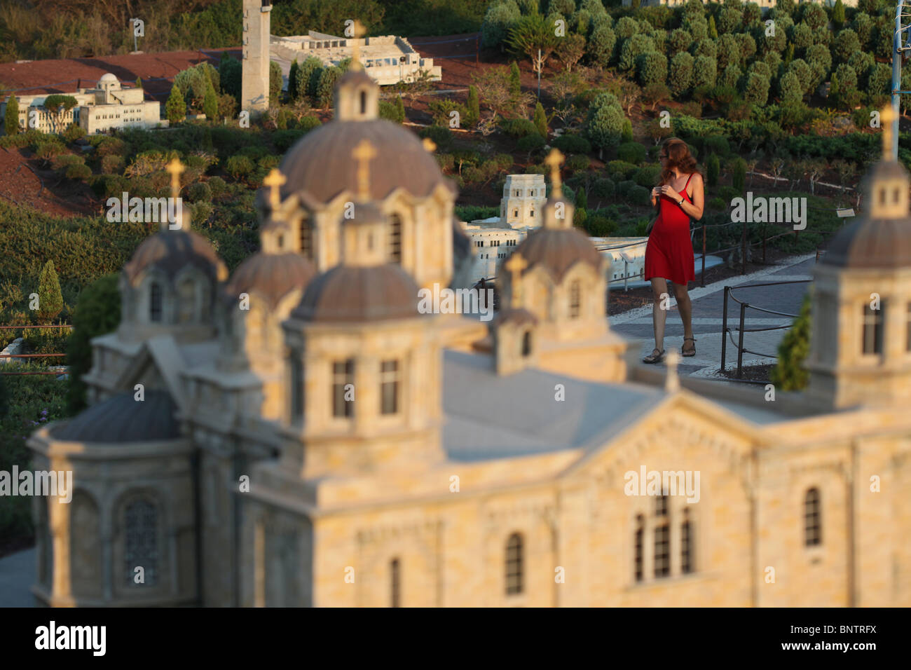 A visitor walking amid miniature replica of Jerusalem landmarks in Mini ...