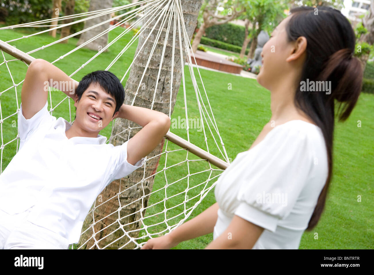 Portrait of a young couple in a hammock Stock Photo - Alamy