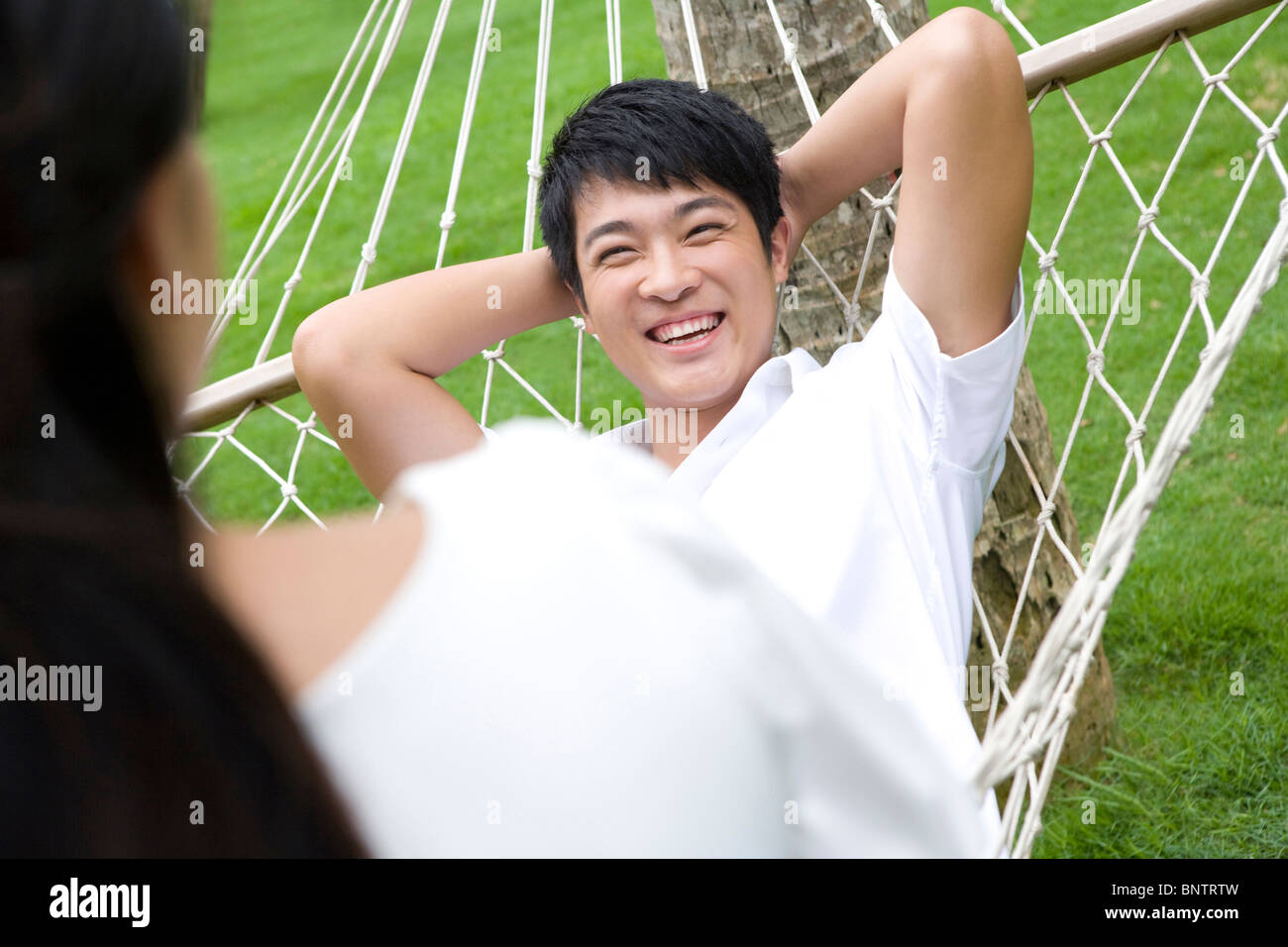 Portrait of a young couple in a hammock Stock Photo - Alamy