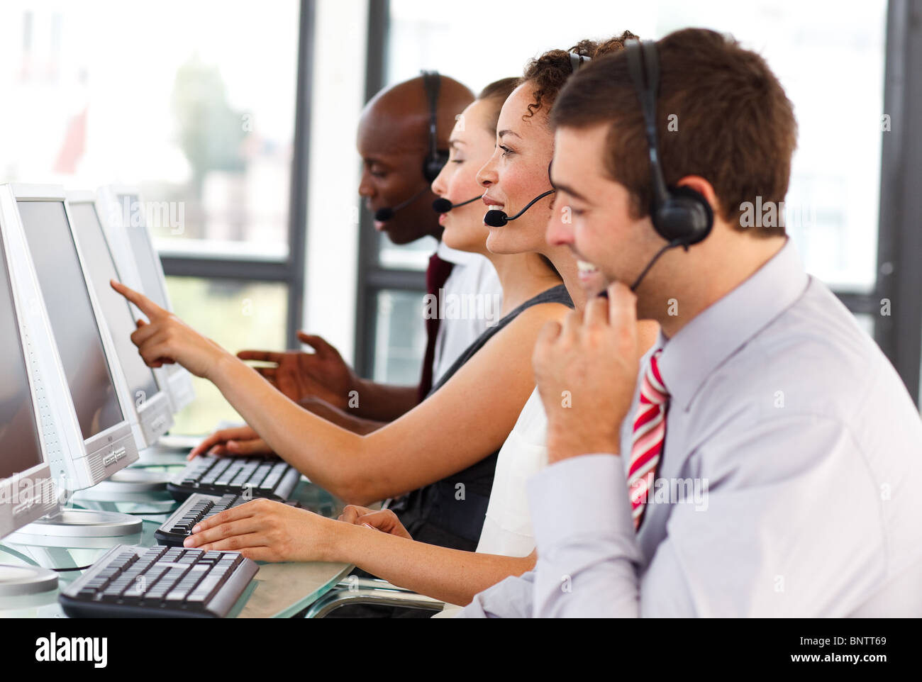 Attractive businessman working in a call center Stock Photo - Alamy