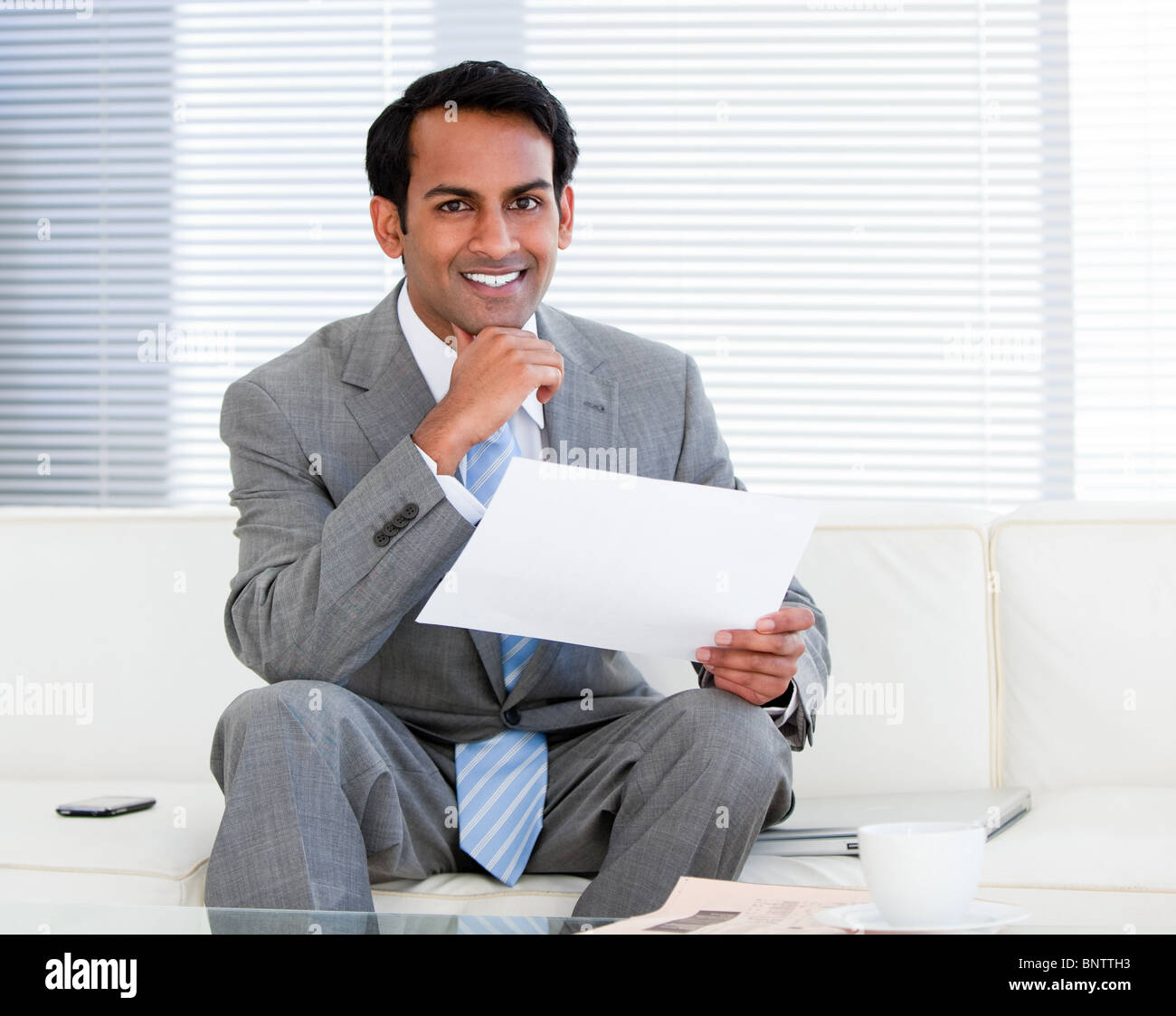 Smiling businessman holding a note Stock Photo - Alamy