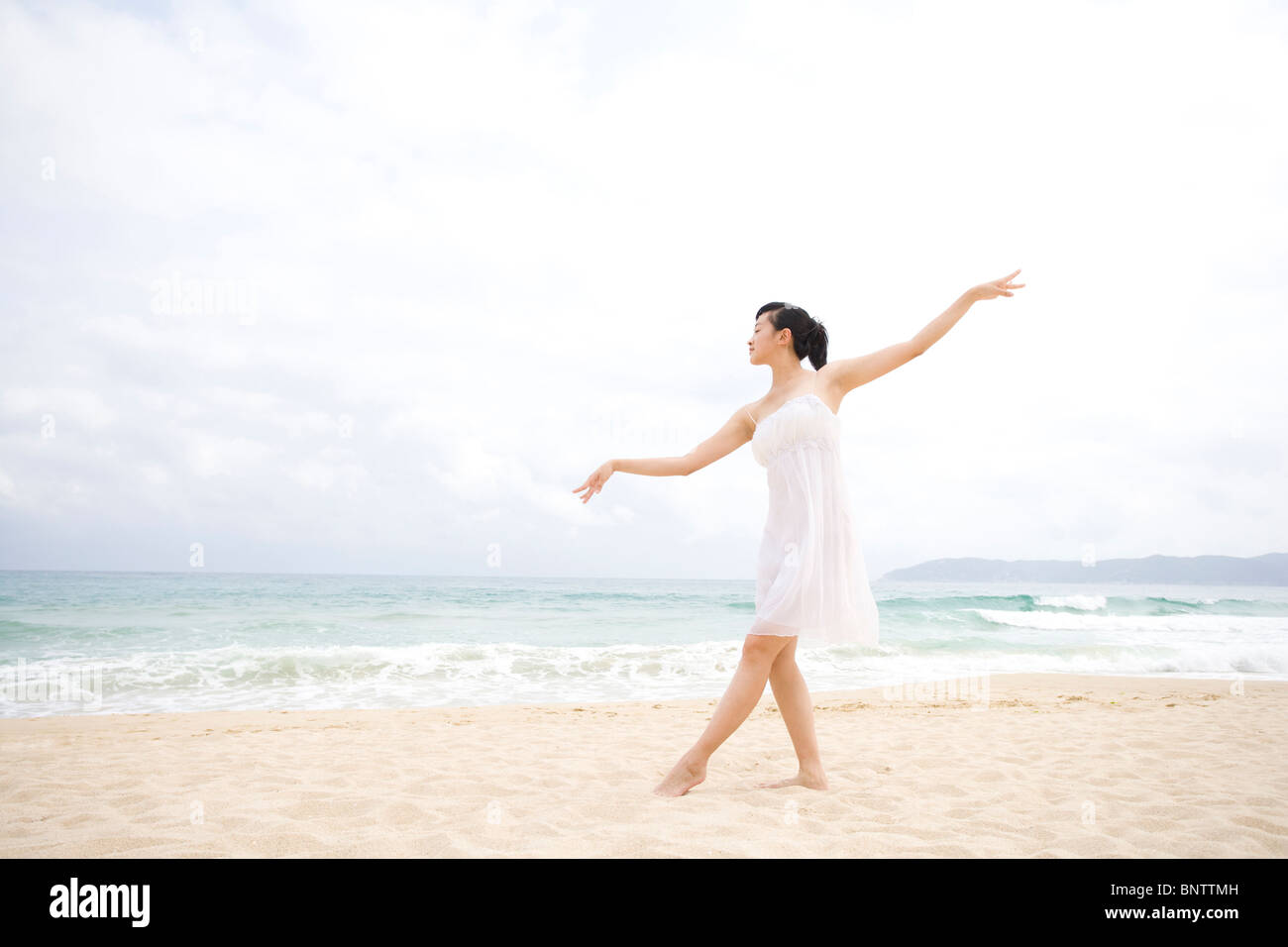 A woman dancing at the beach Stock Photo - Alamy