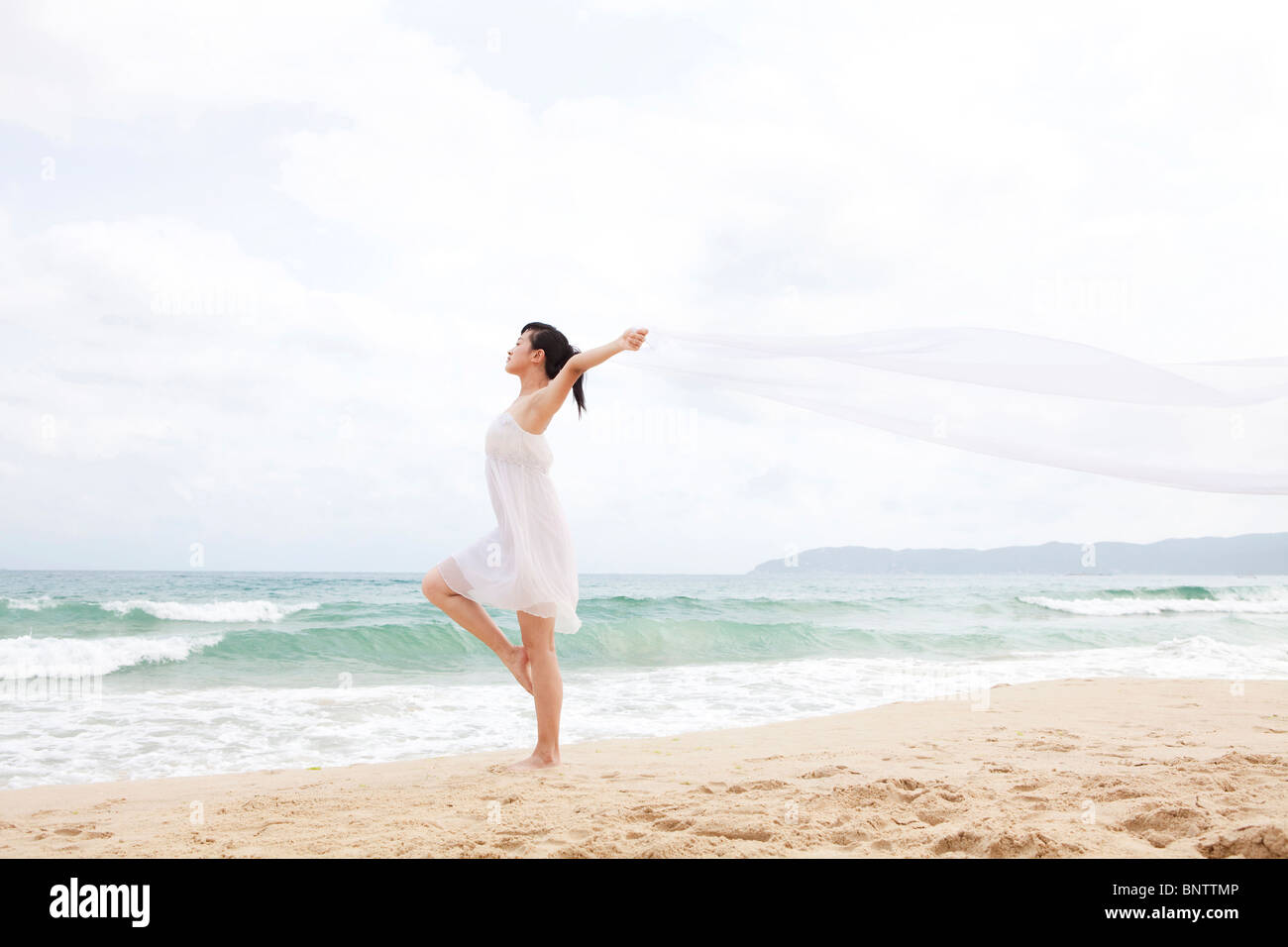 A woman dancing at the beach Stock Photo - Alamy