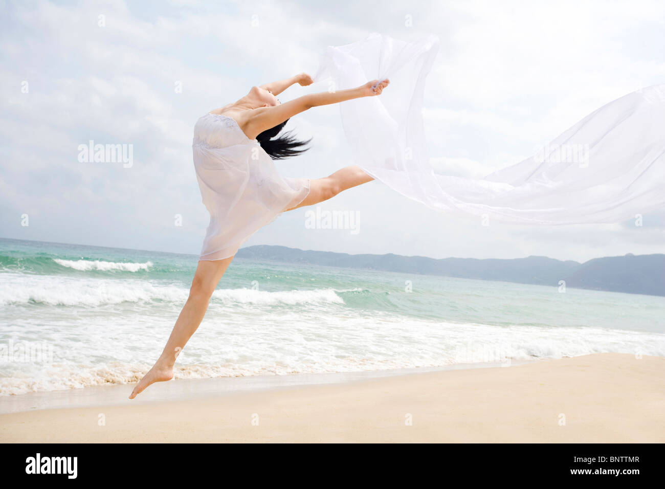 A woman dancing at the beach Stock Photo - Alamy