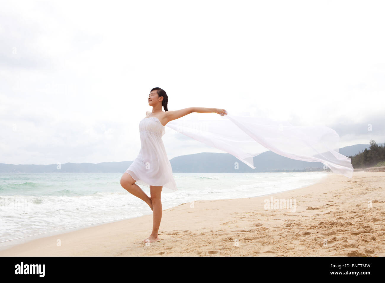 A woman dancing at the beach Stock Photo - Alamy