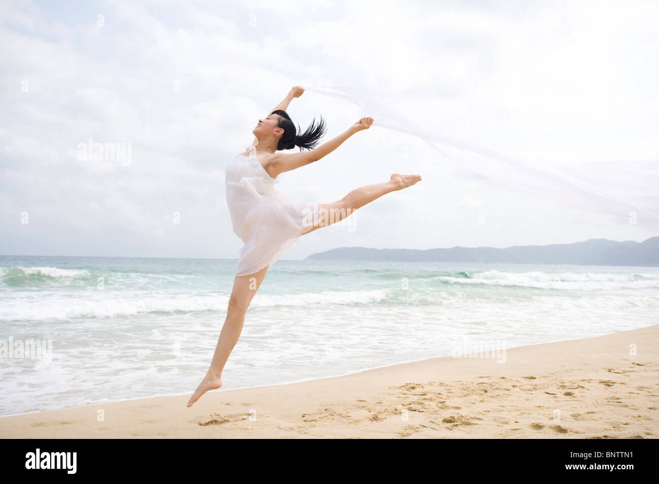 A woman dancing at the beach Stock Photo - Alamy