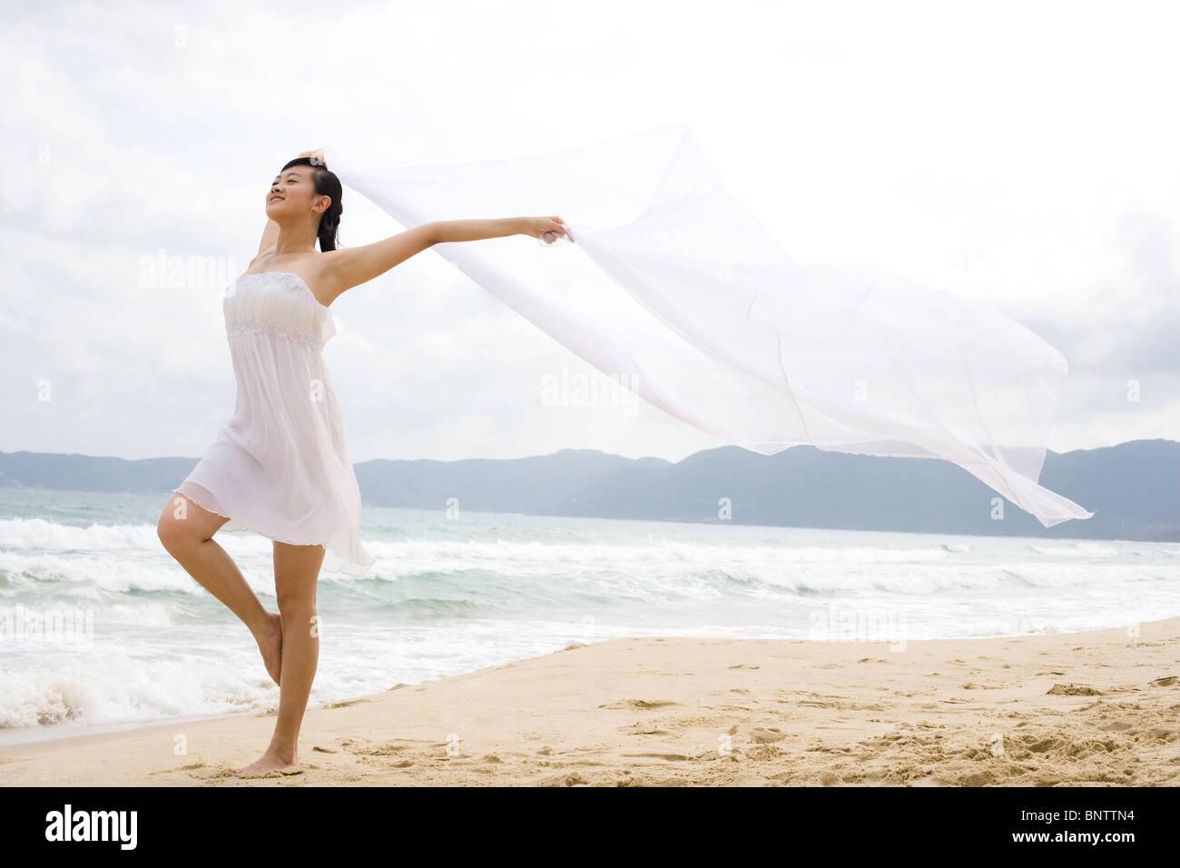 A woman dancing at the beach Stock Photo - Alamy