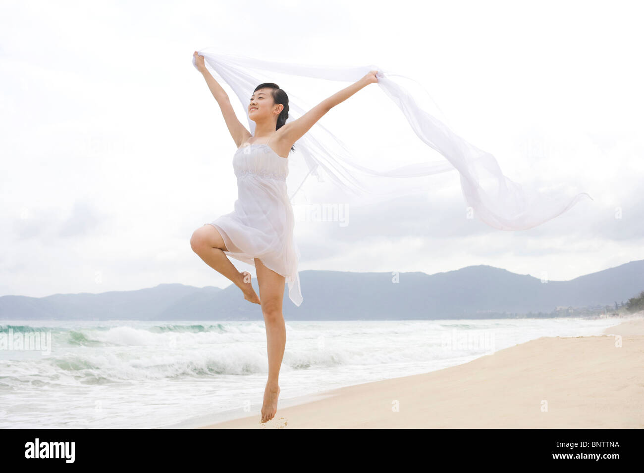 A woman dancing at the beach Stock Photo - Alamy