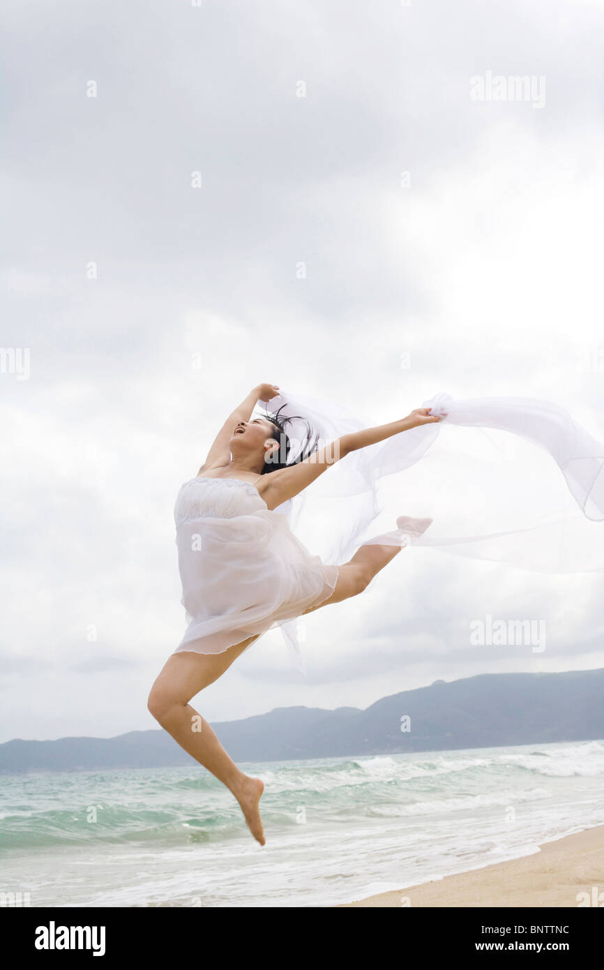 A woman dancing at the beach Stock Photo - Alamy