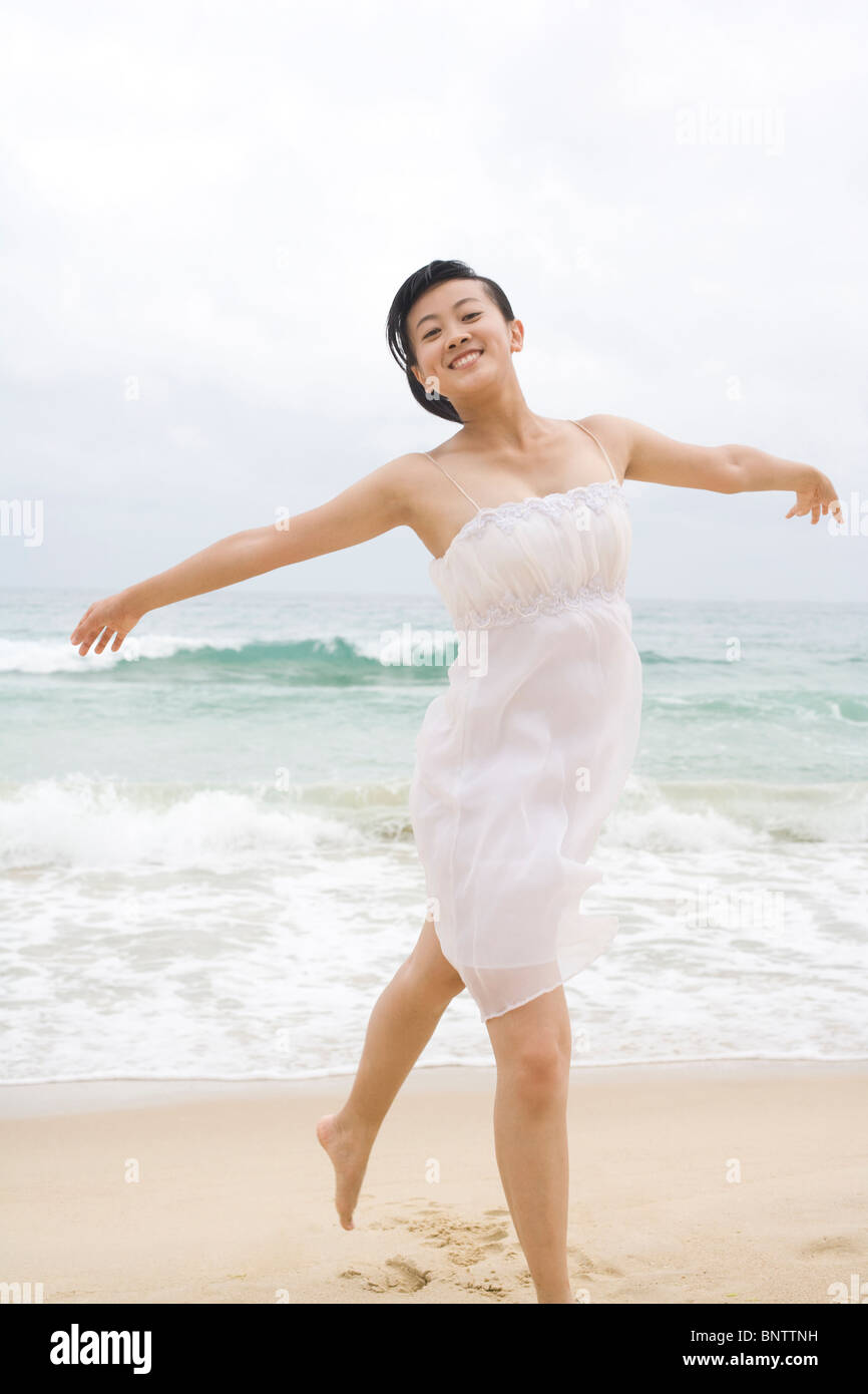 A woman dancing at the beach Stock Photo - Alamy