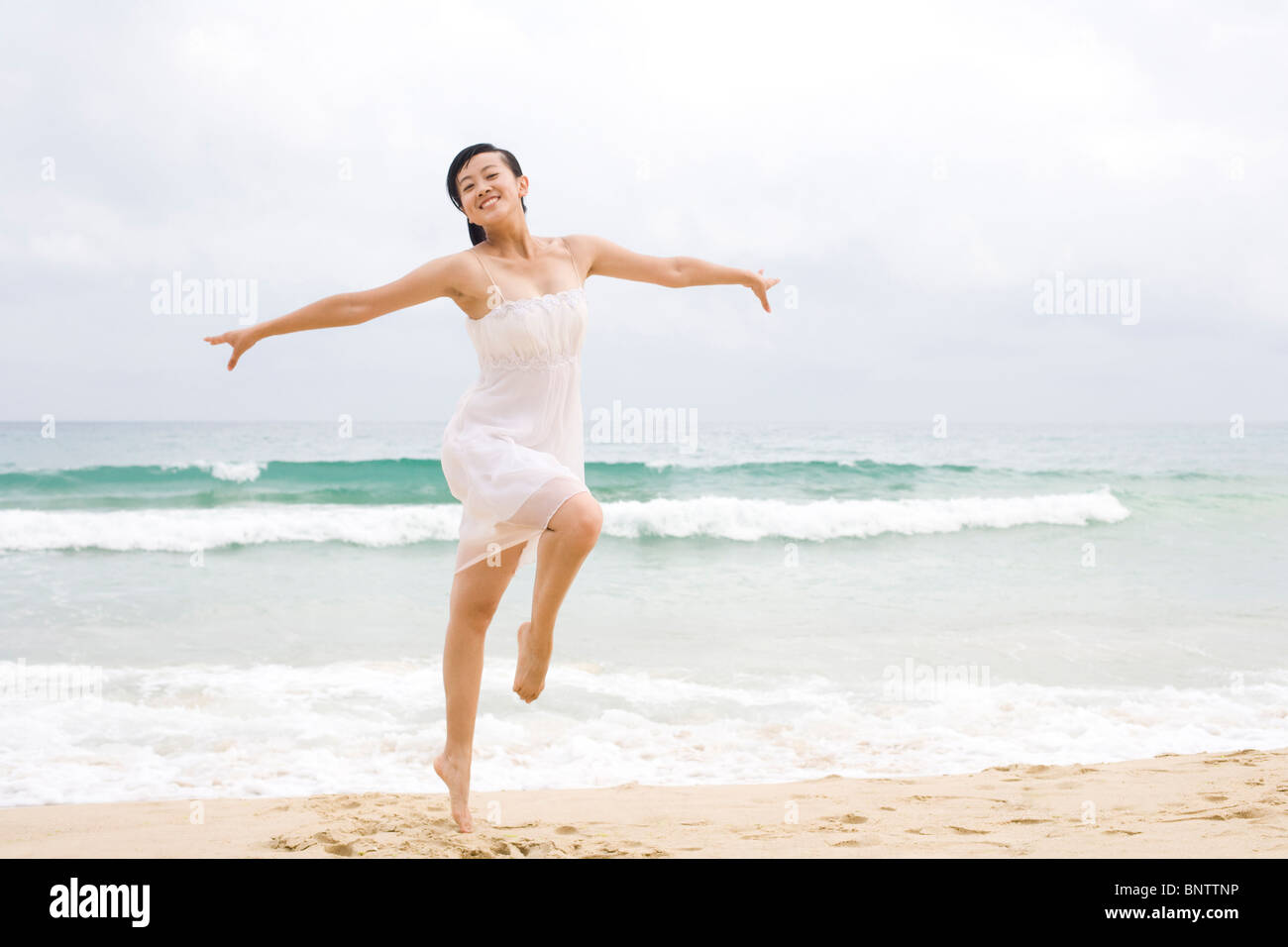 A woman dancing at the beach Stock Photo - Alamy